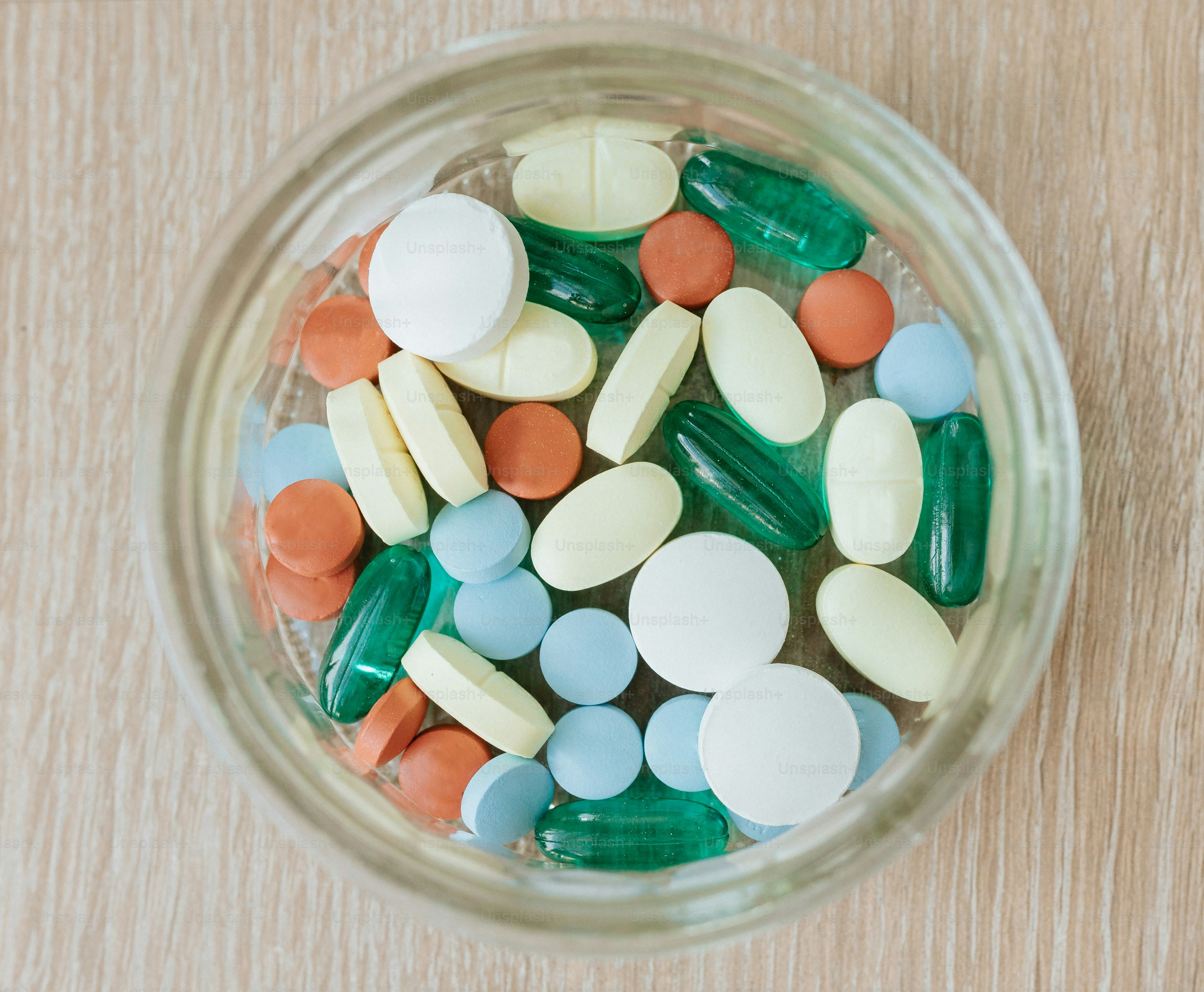 A close up of a jar of pills on a table photo – Pill bottle Image on ...