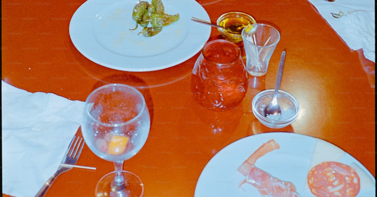 A Table With Plates Glasses And Utensils On It Photo Analog Image On Unsplash