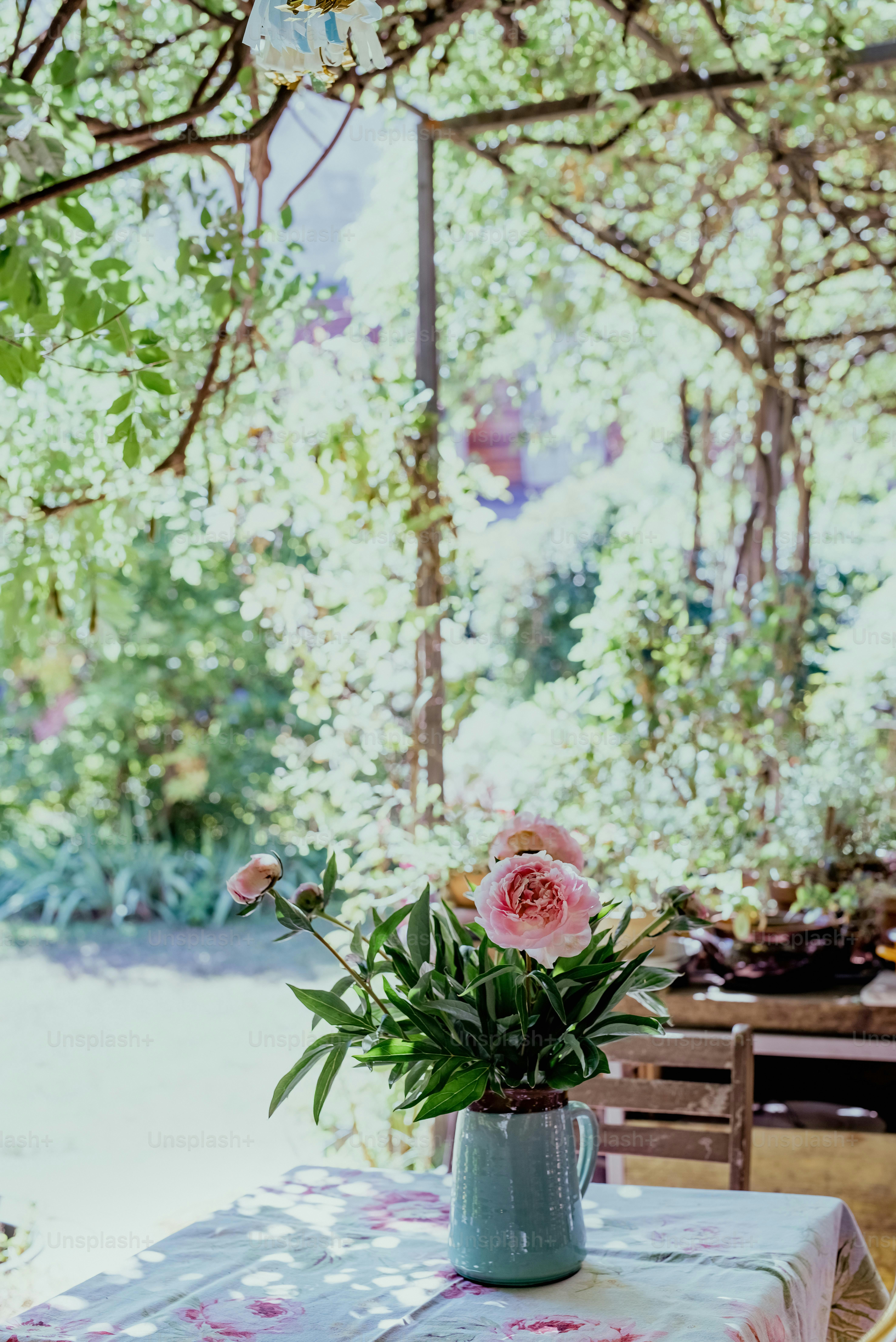 A table with a vase of flowers on top of it photo – Spring Image on ...