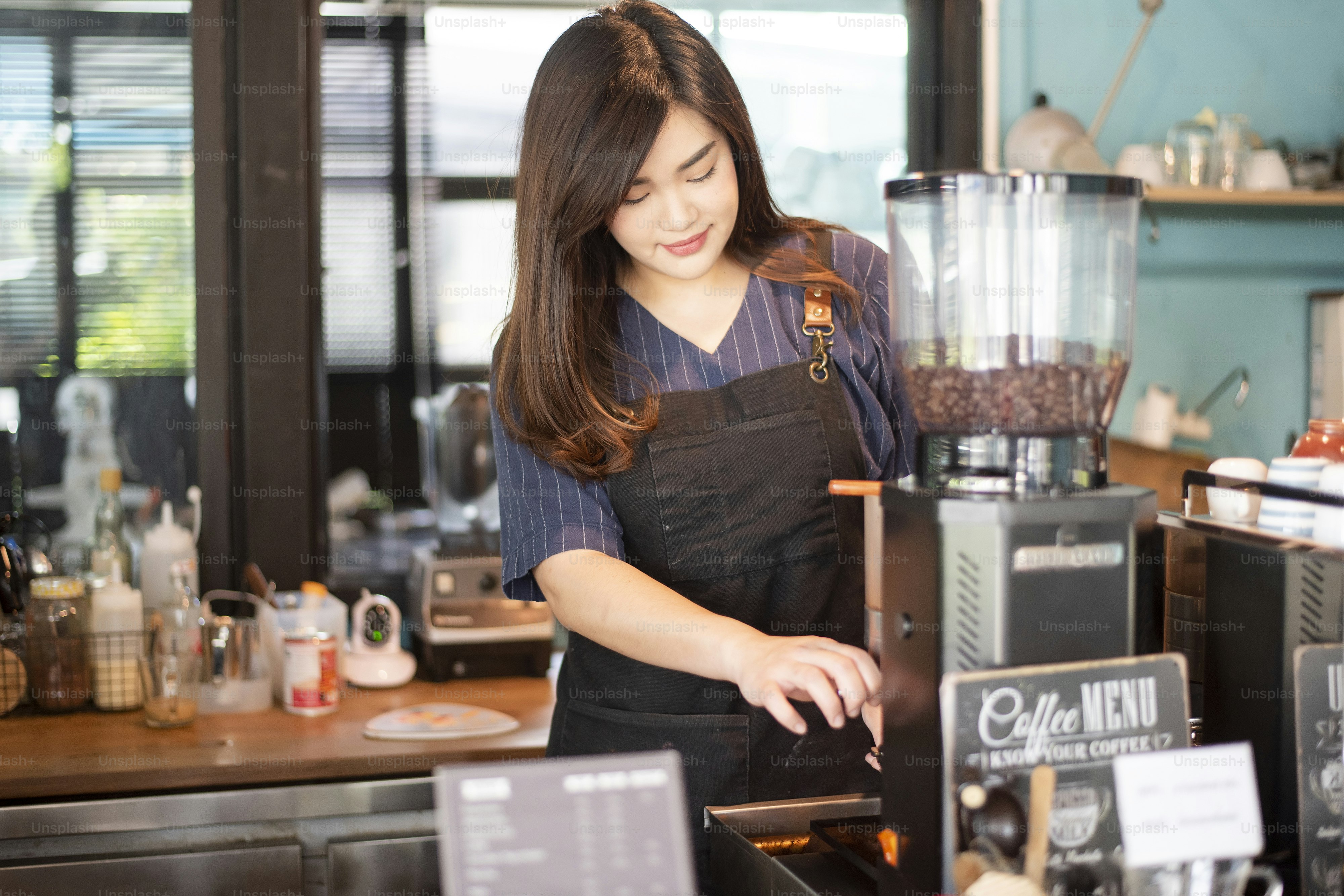 Beautiful barista is smiling in her coffee shop photo – Cafeteria Image ...