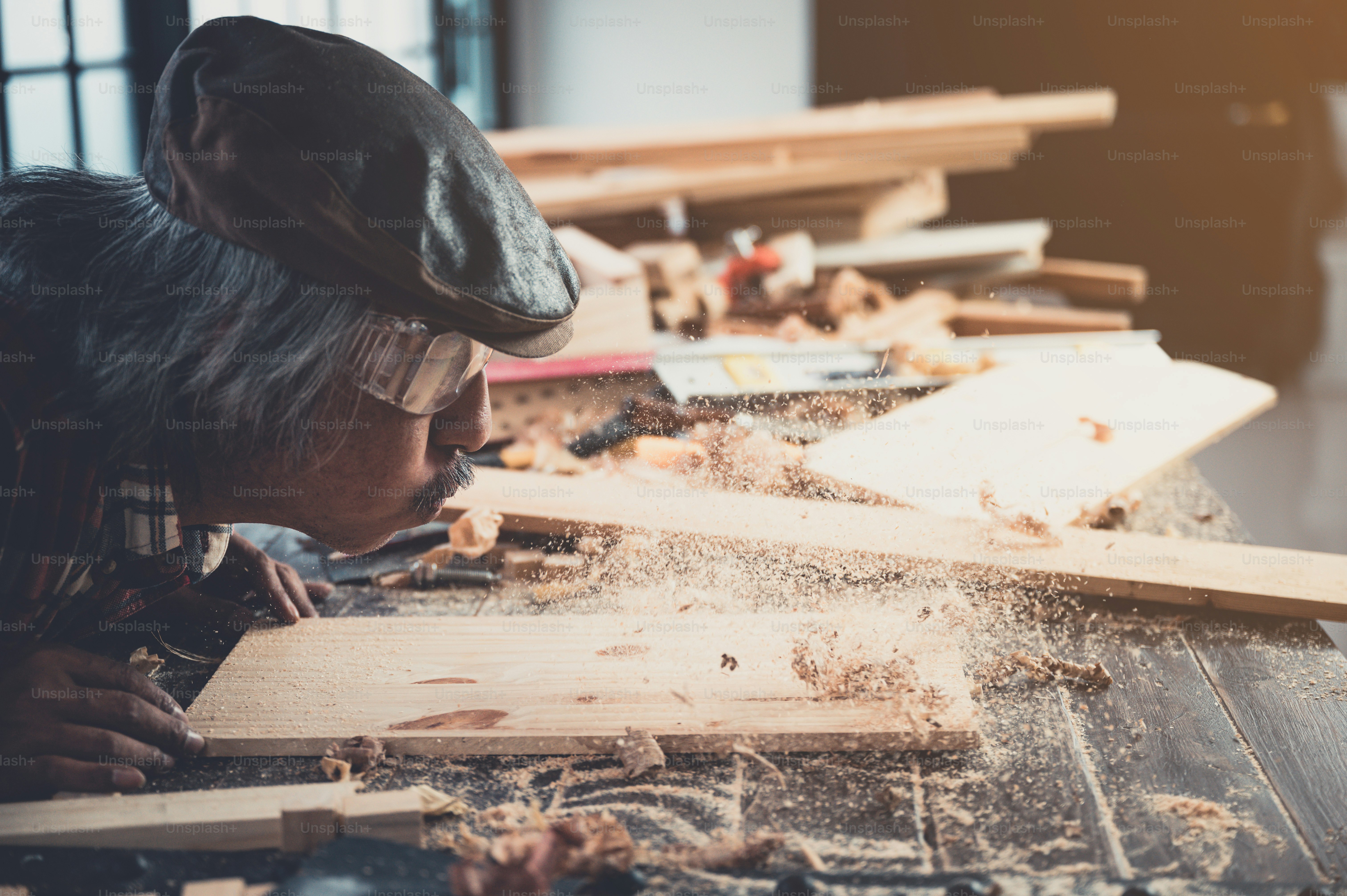 Man doing woodwork in carpentry. Carpenter work on wood plank in ...