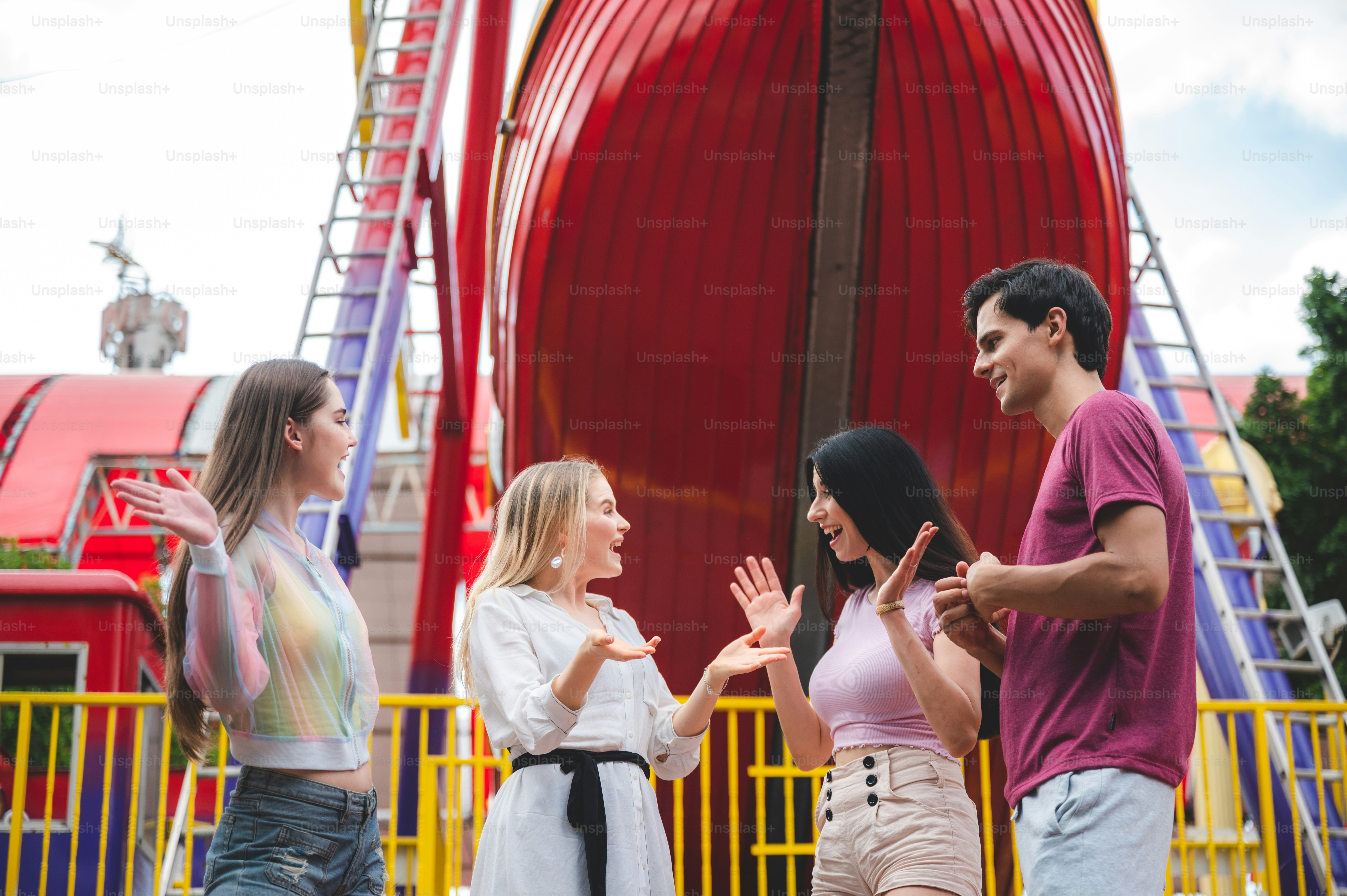 Group of friends having fun and relaxing at an amusement theme park ...