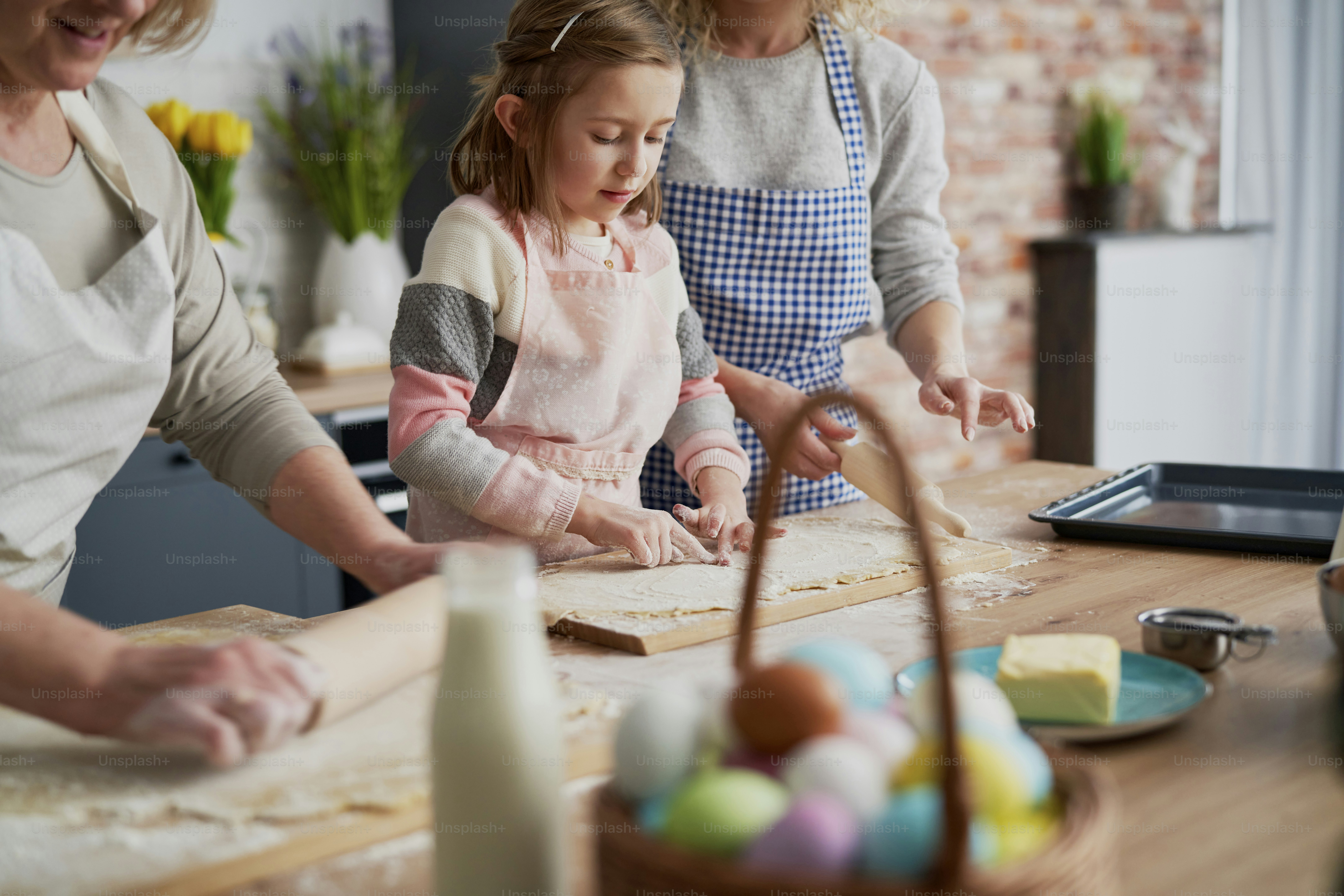 Little girl helping during Easter baking in the kitchen photo ...