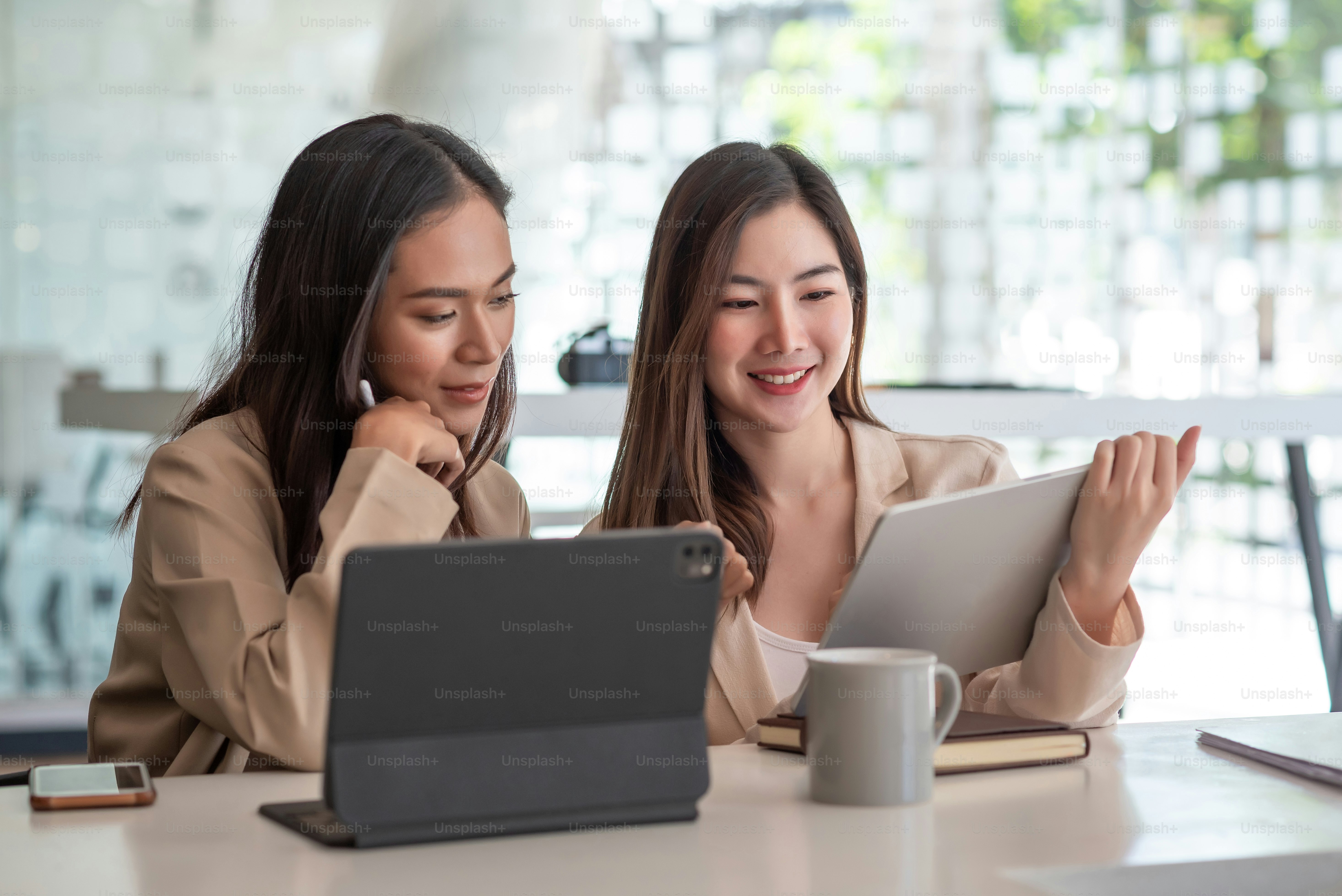 Young Asian businesswoman work together to analysis from work at the office. photo – Females ...