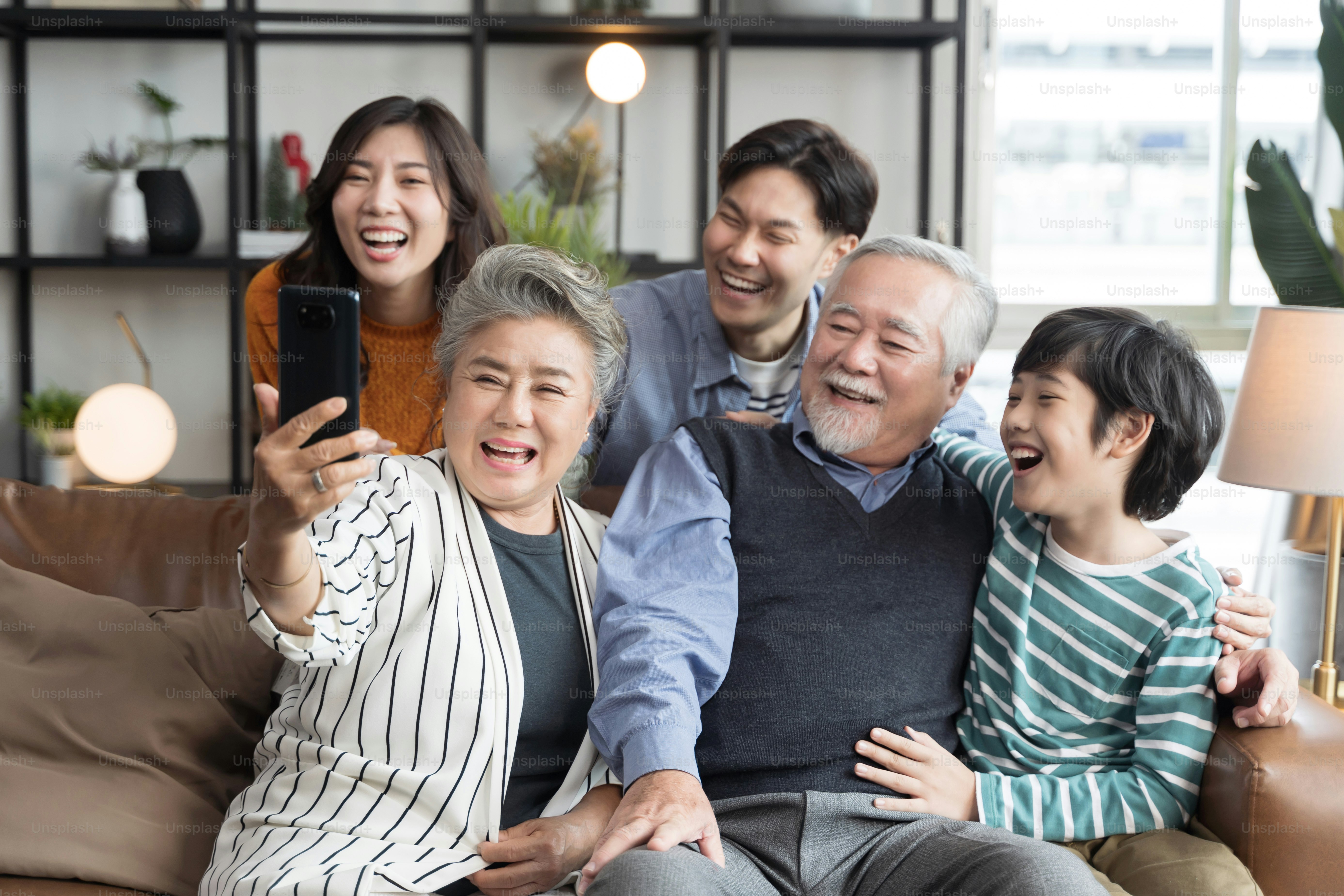 Asian big family taking selfie together at home photo – Communicate ...
