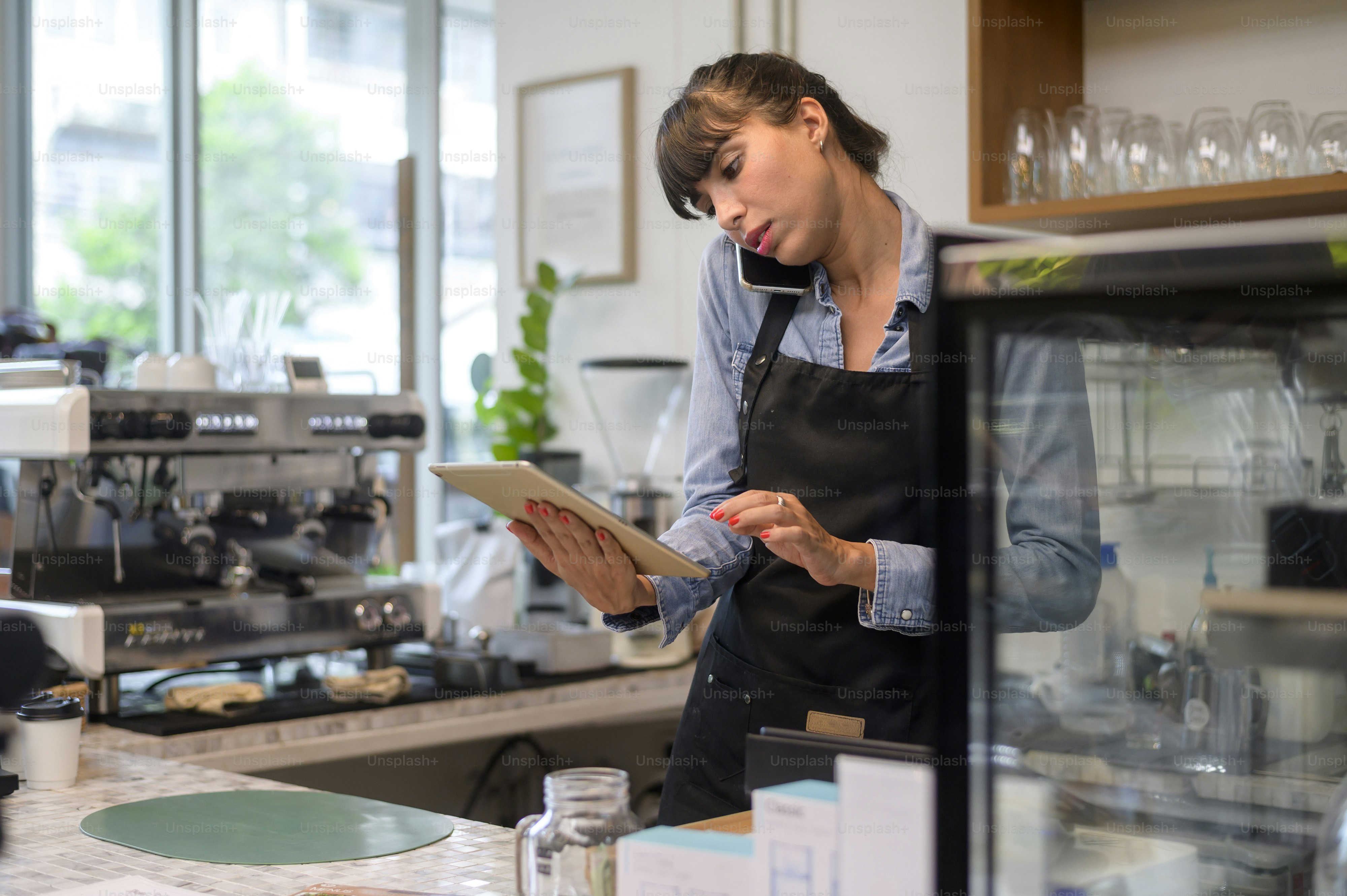 Young service minded barista woman working in coffee shop photo ...