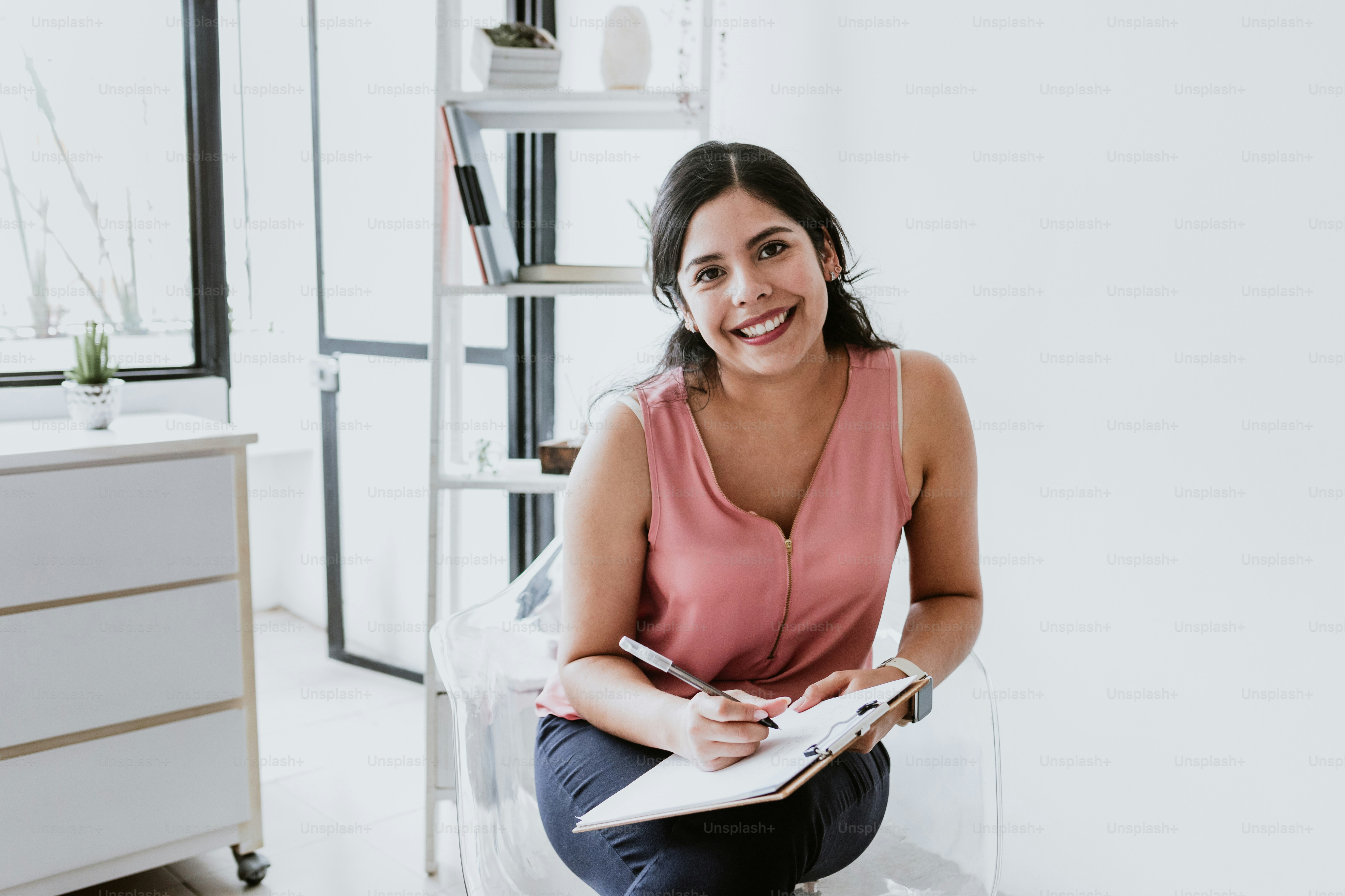 Hispanic young woman psychologist holding clipboard at psychology ...