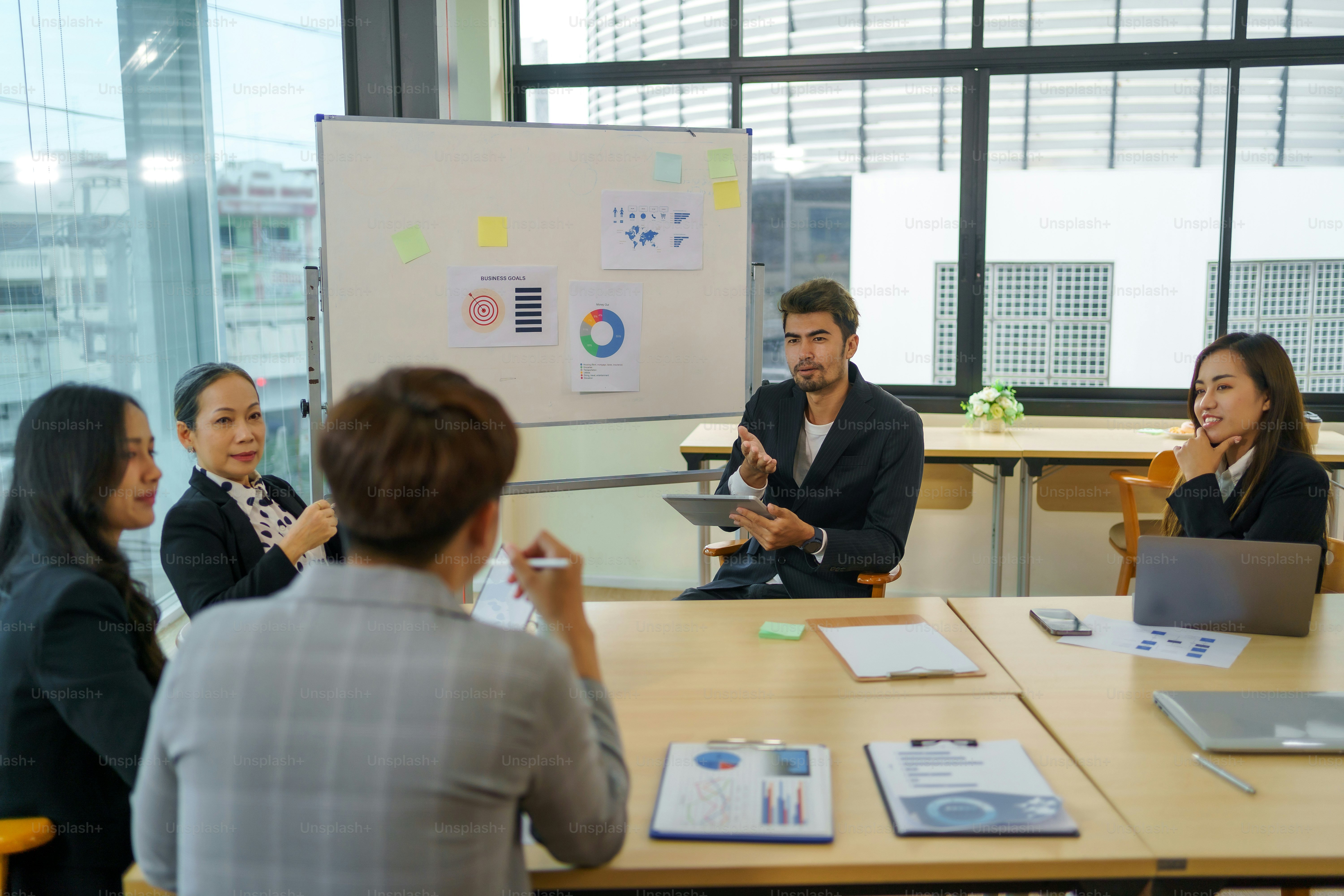 Meeting of Asian business people who are committed to work. Creative ...