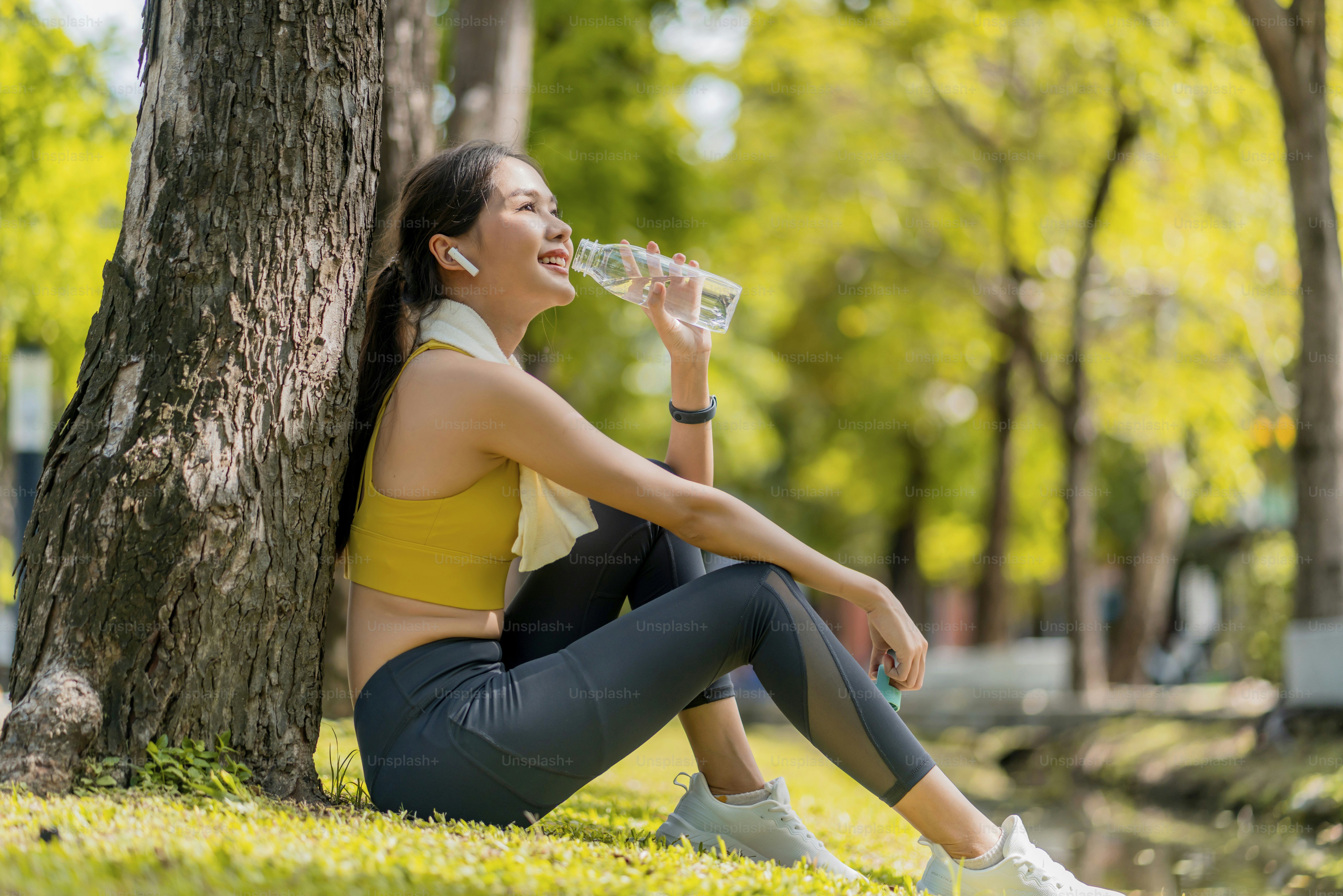 Young Woman drinking water from bottle. asian female drinking water ...