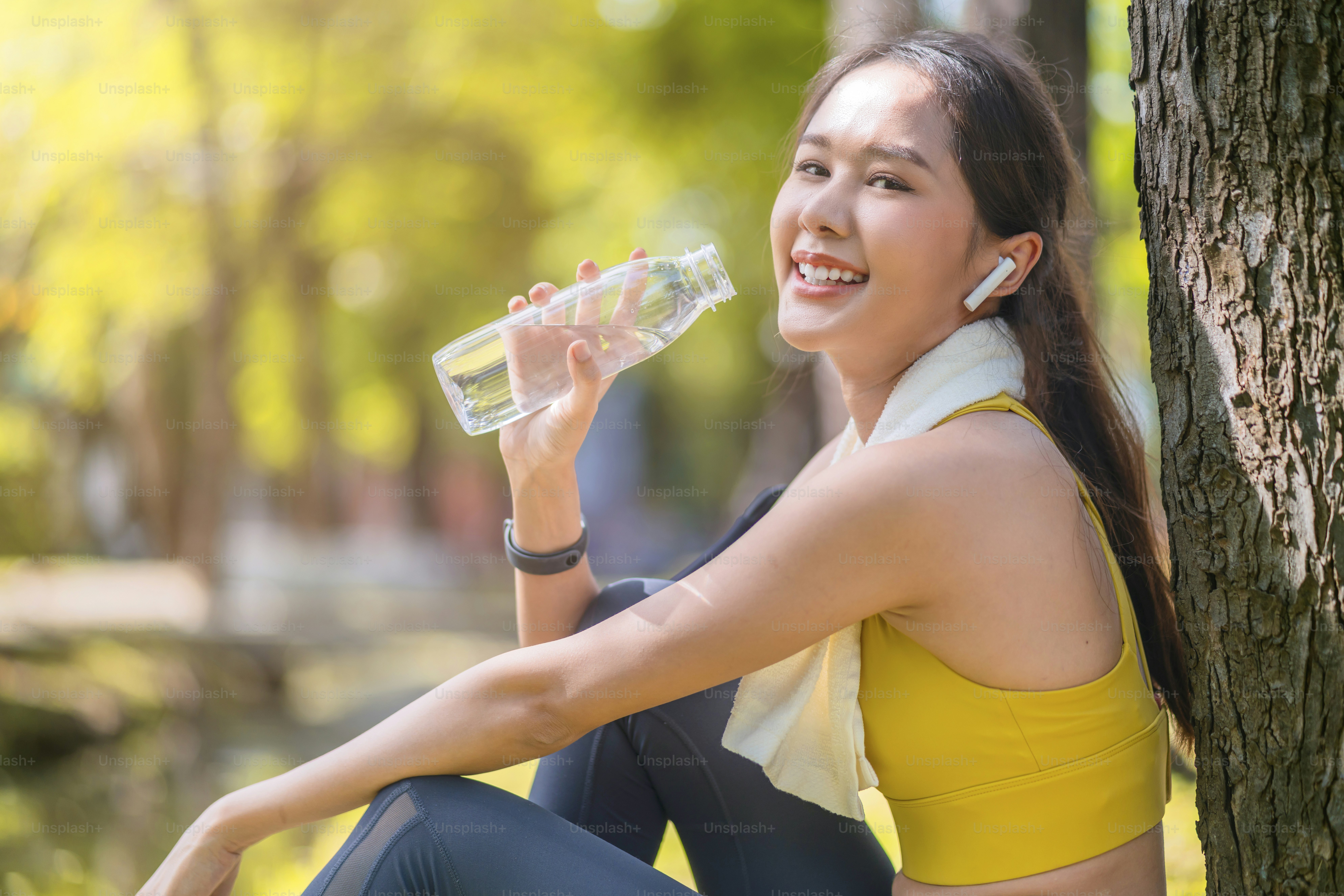 Young Woman drinking water from bottle asian female drinking water ...