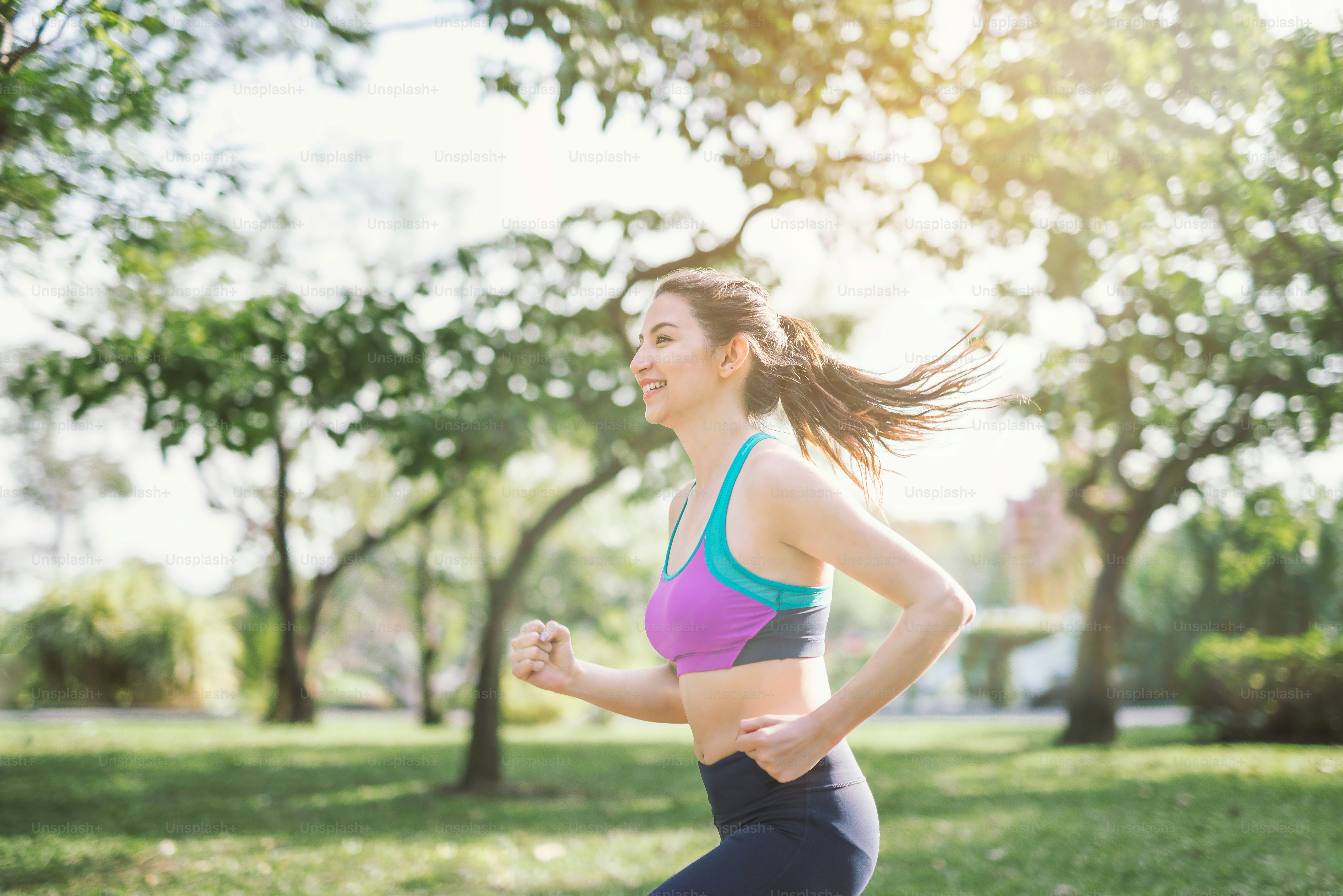 Athletic woman running outdoors. Action and healthy lifestyle concept ...