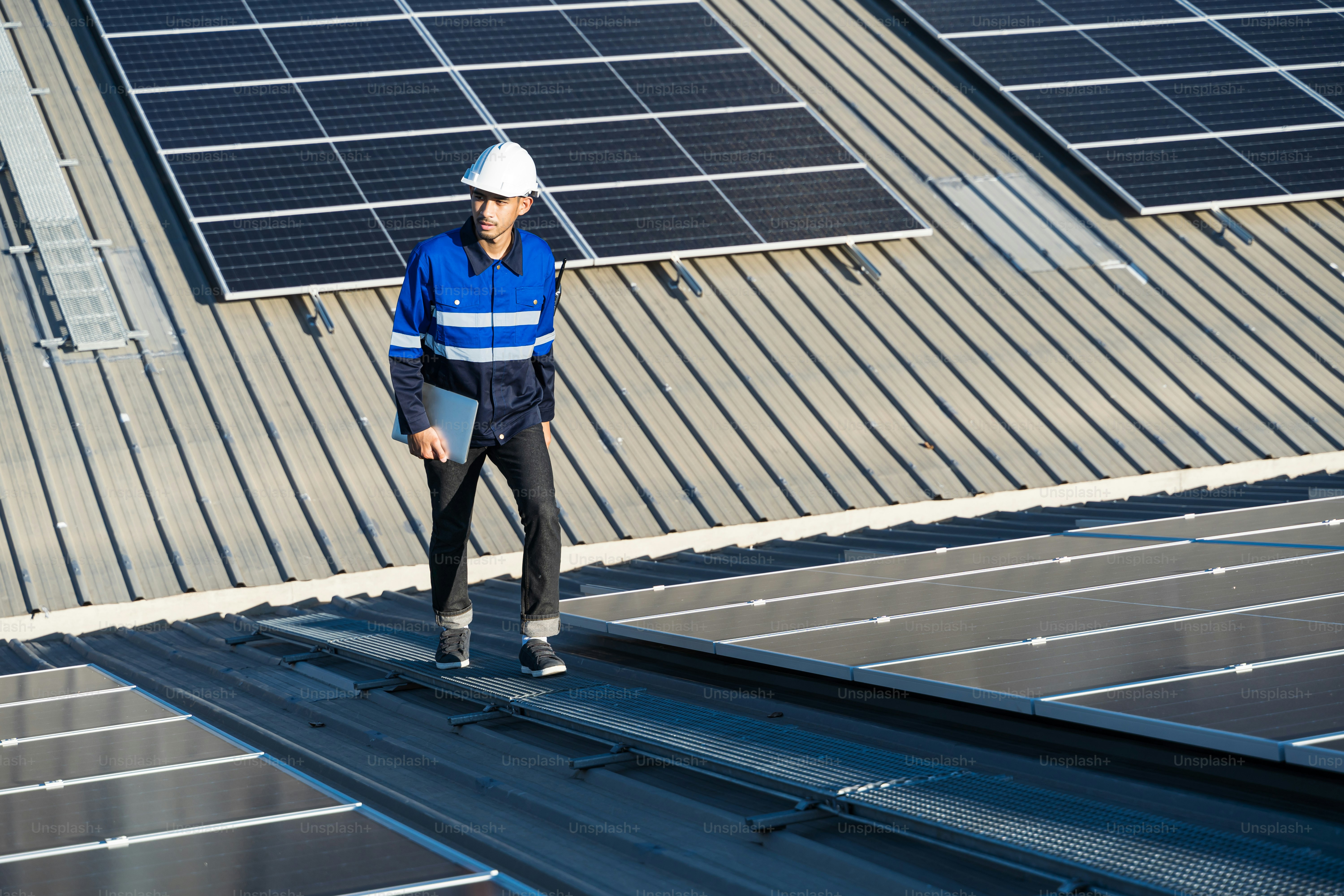 Portrait of Asian engineer on background field of photovoltaic solar ...