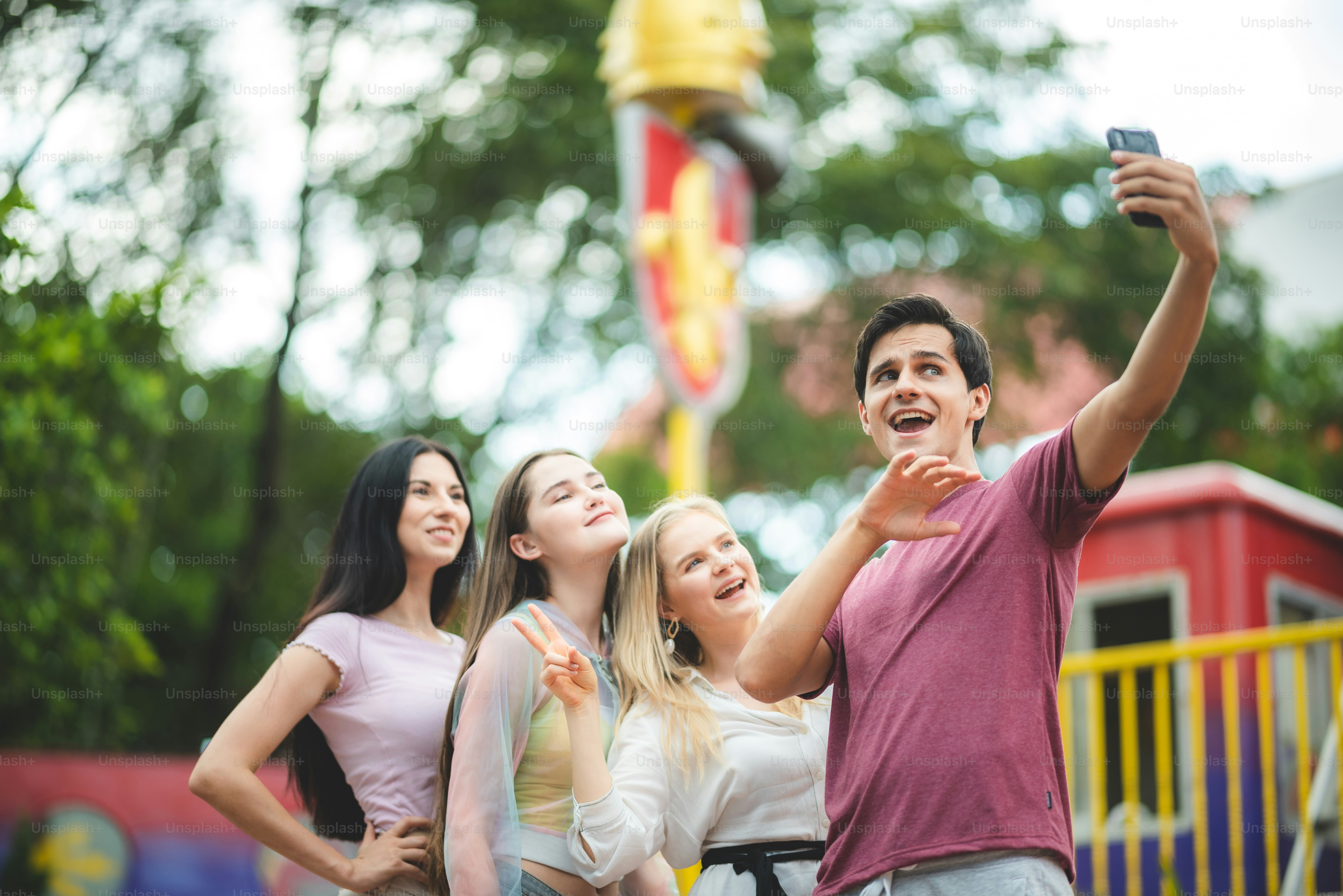 Friends group relaxing and taking selfie with smartphone at an ...