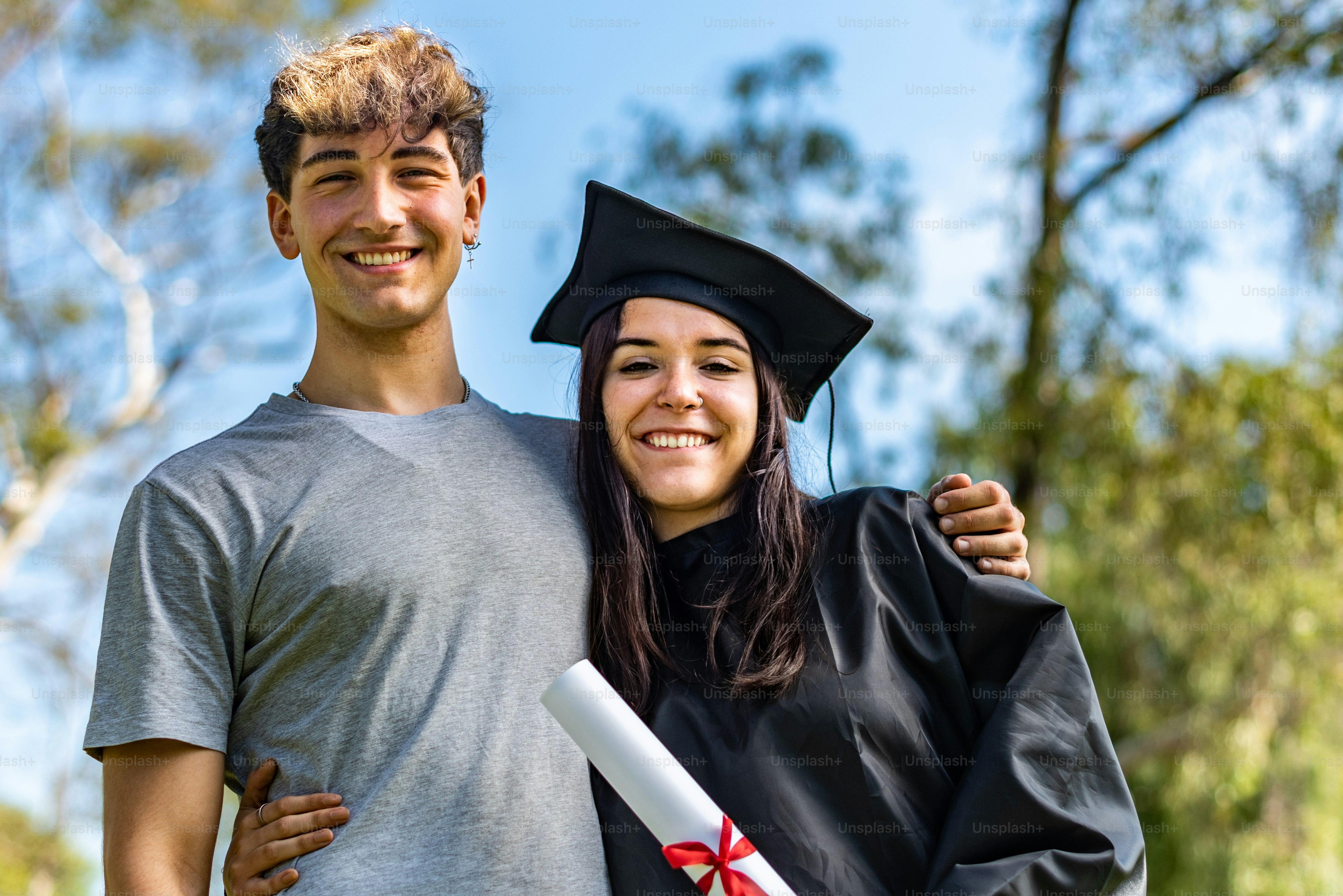 Happy caucasian graduated girl with her boyfriend or her brother on her ...
