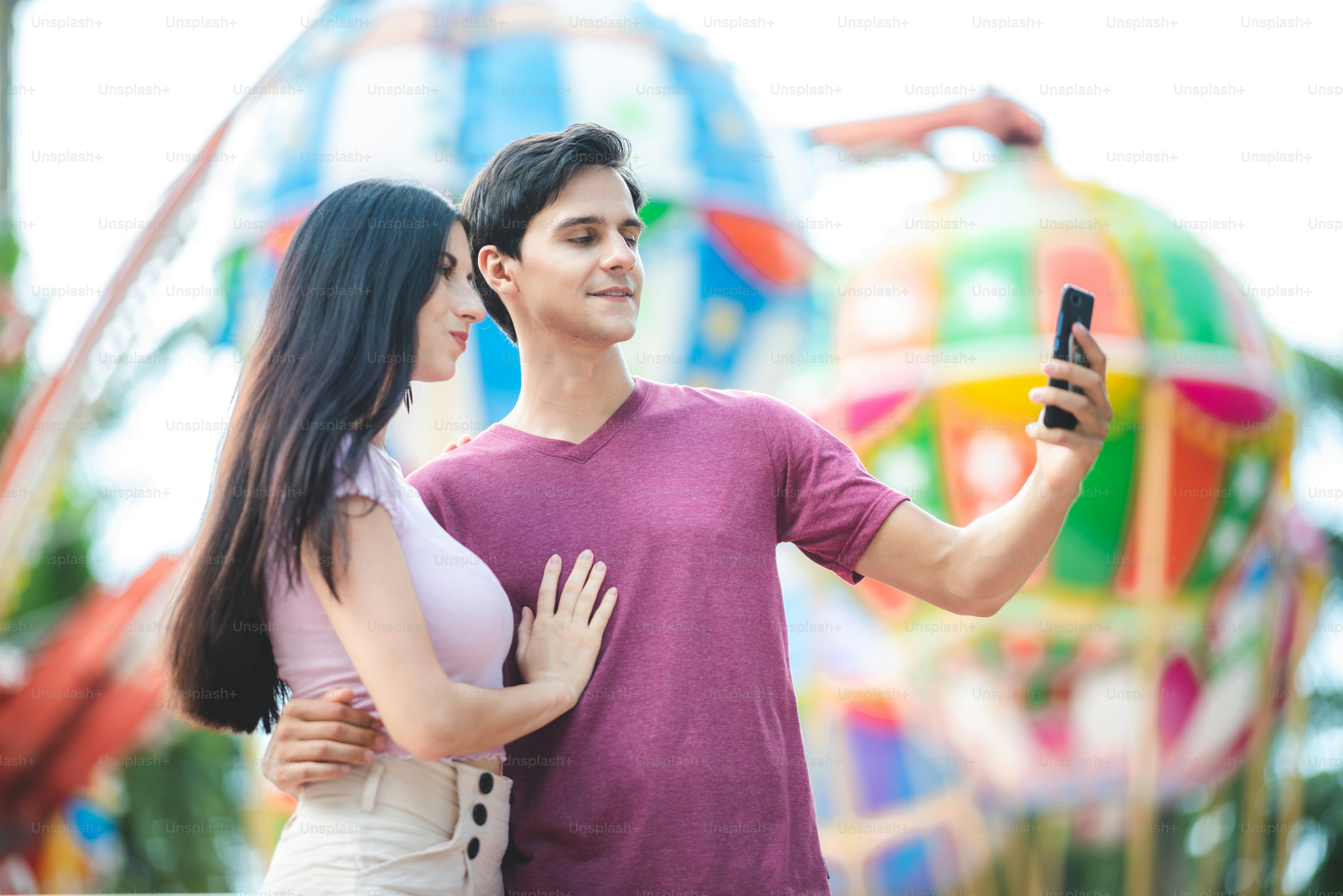 Young couple dating and having fun at amusement park, concept of happy ...