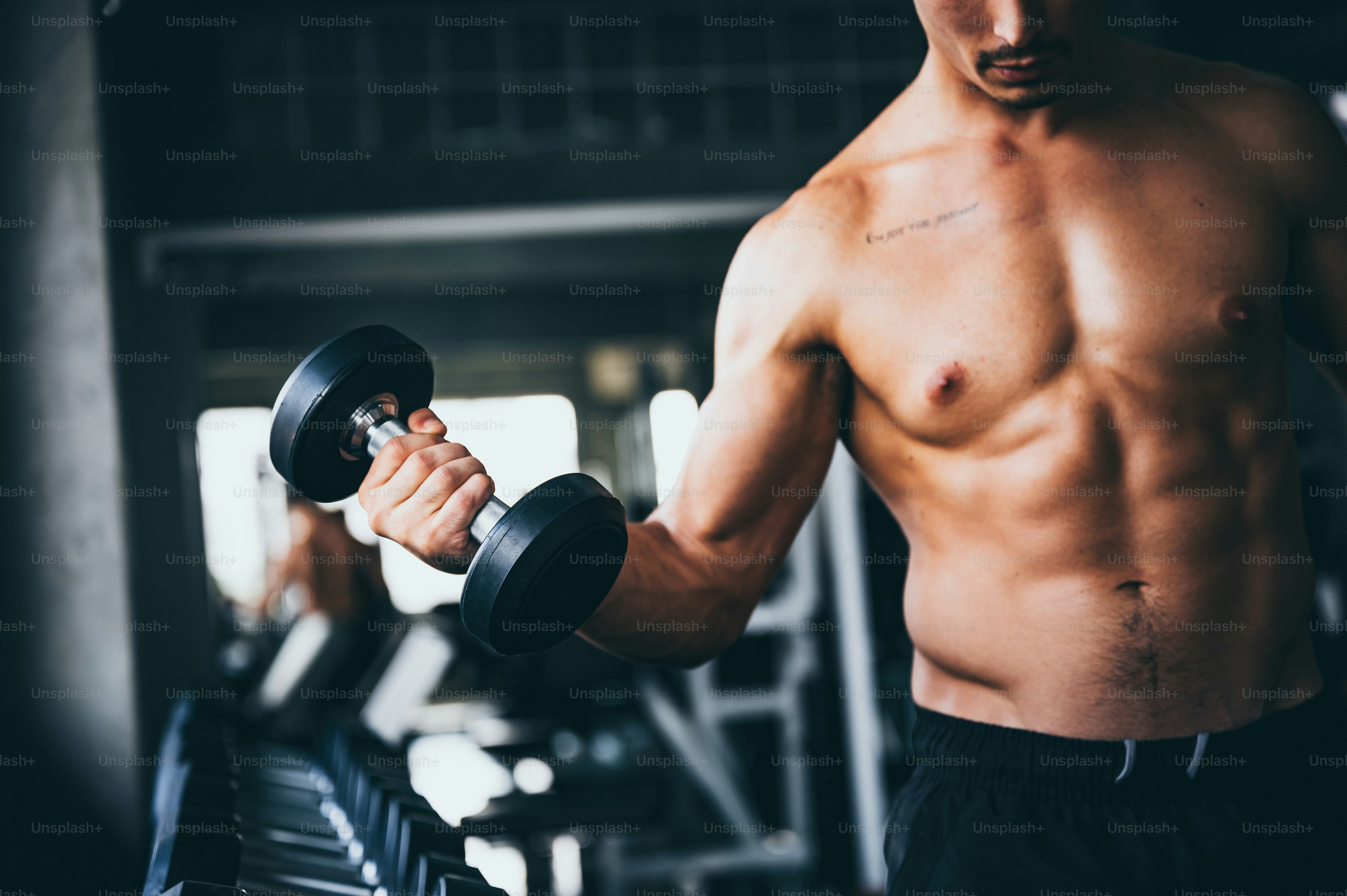 Strong man exercising in the sport gym photo – Bodybuilder Image on ...