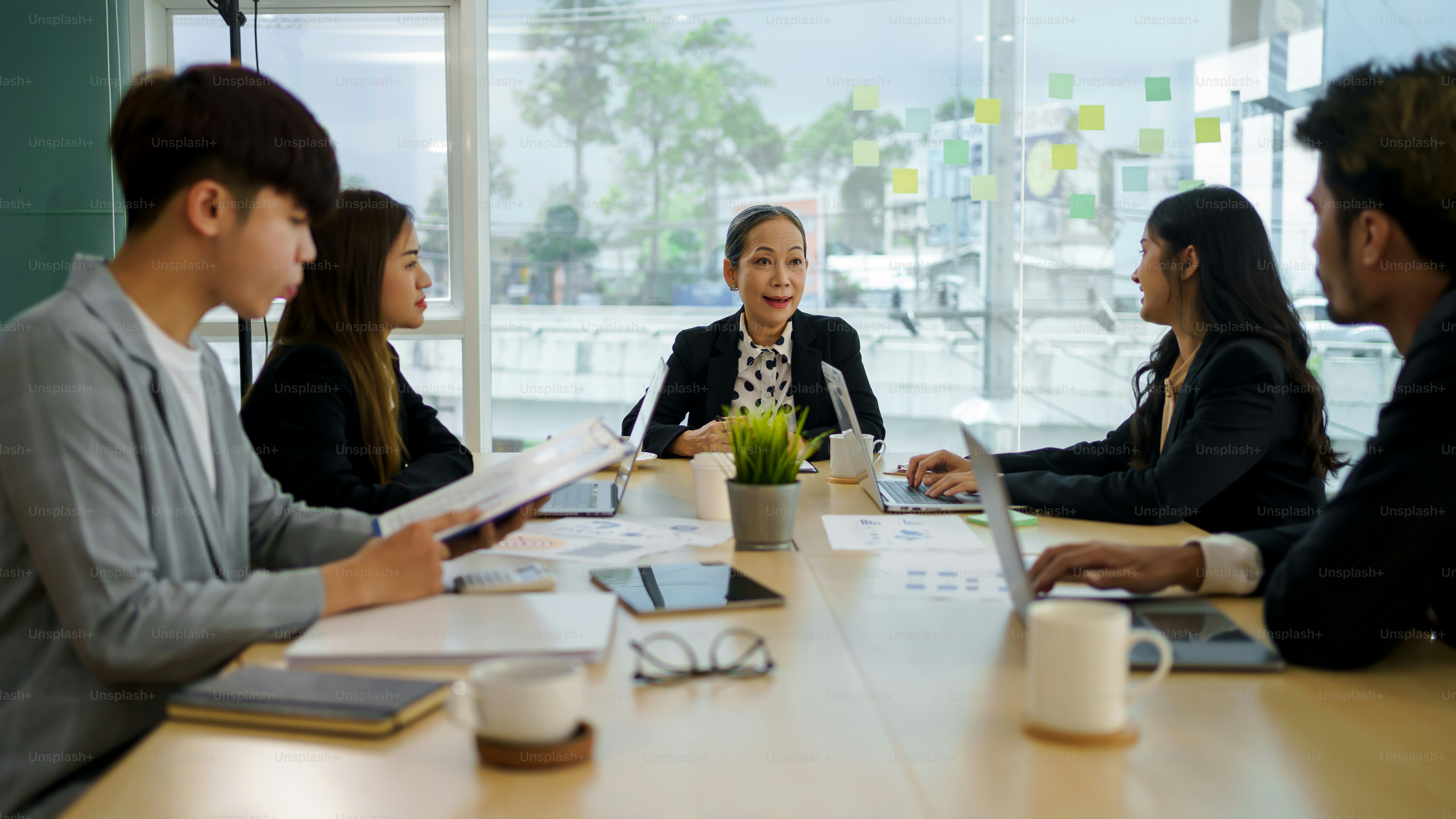 Meeting of Asian business people who are committed to work. Creative ...