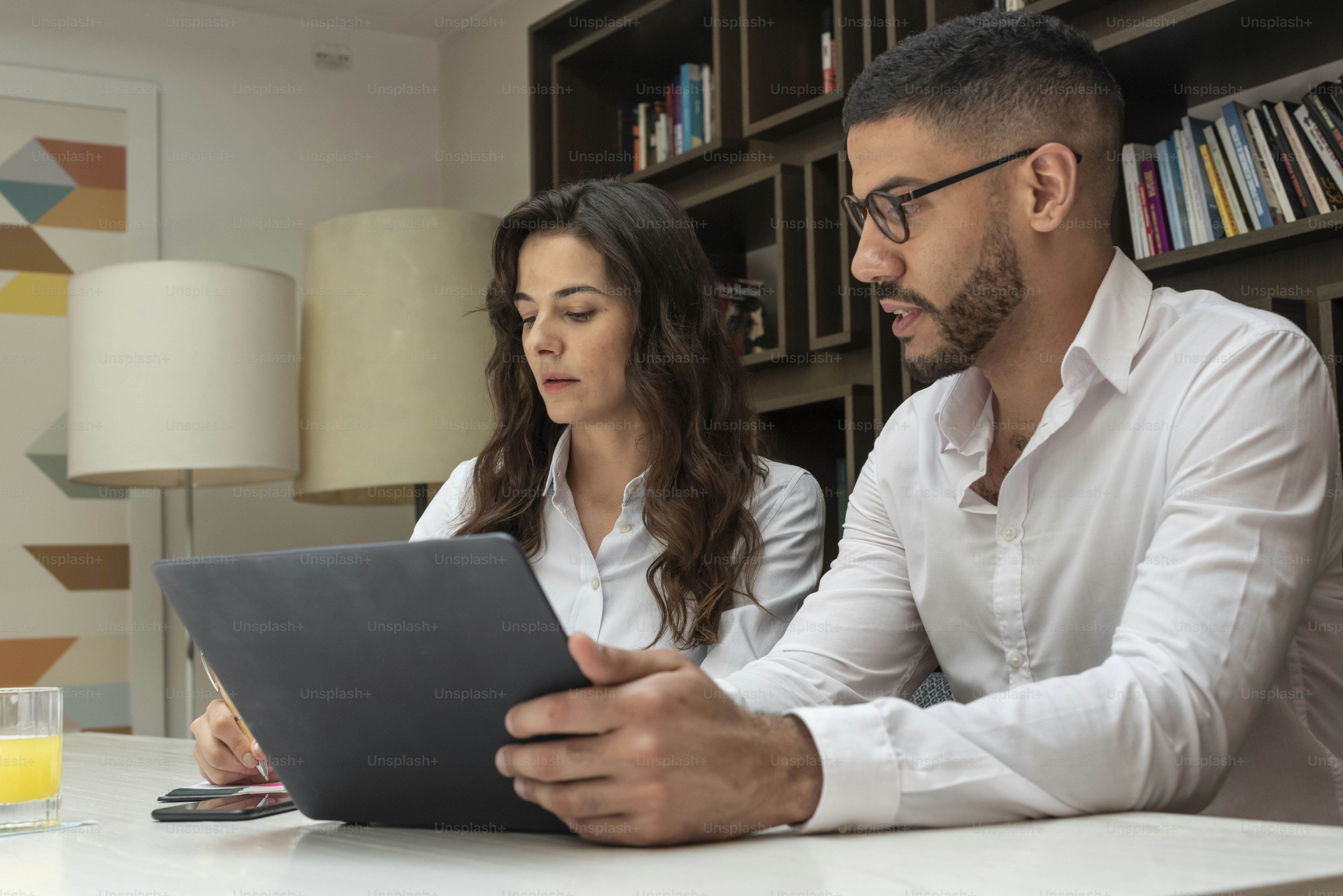 A business couple working together with a laptop. photo – Home office ...