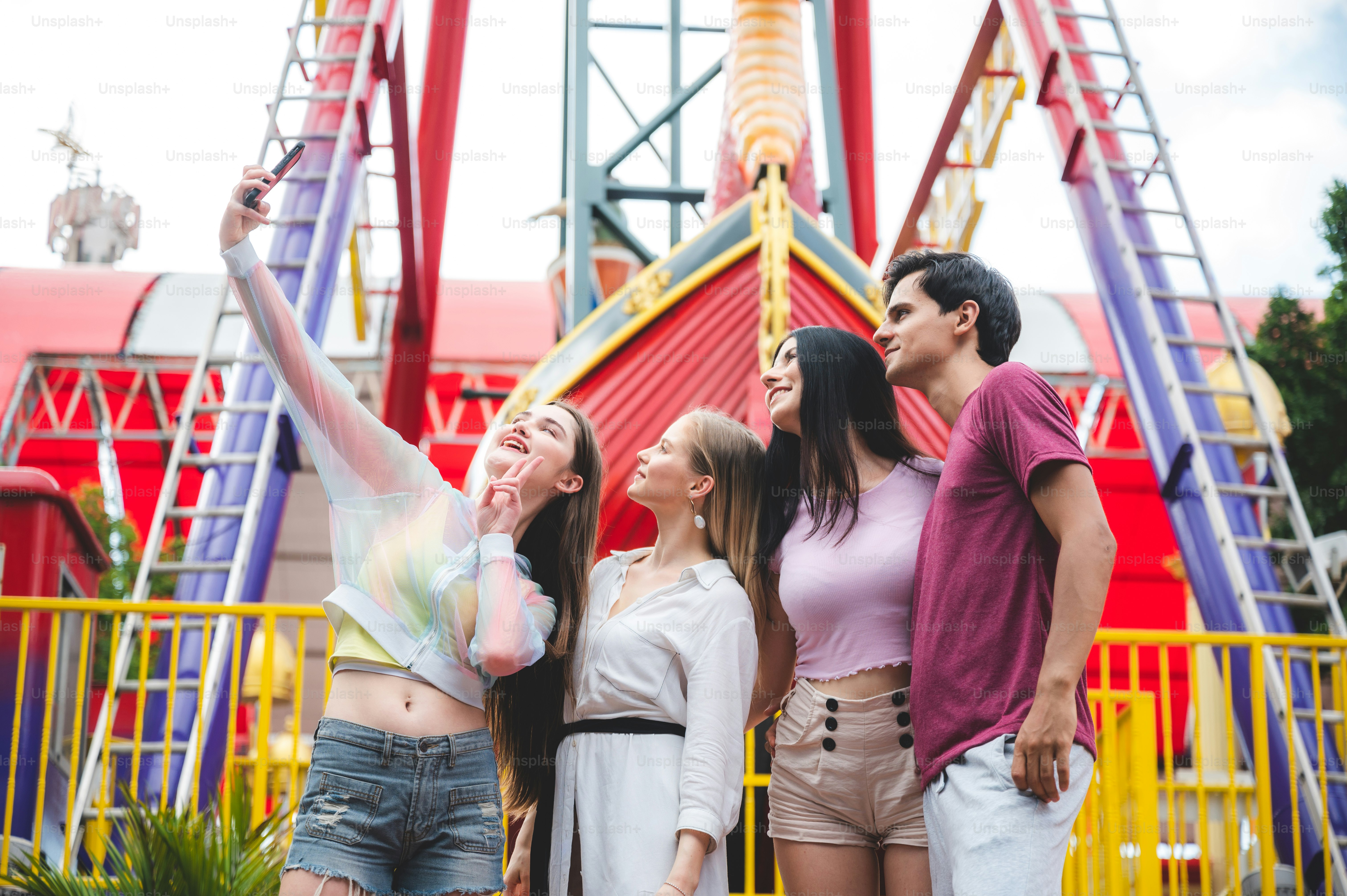 Group of friends having fun and relaxing at an amusement theme park ...