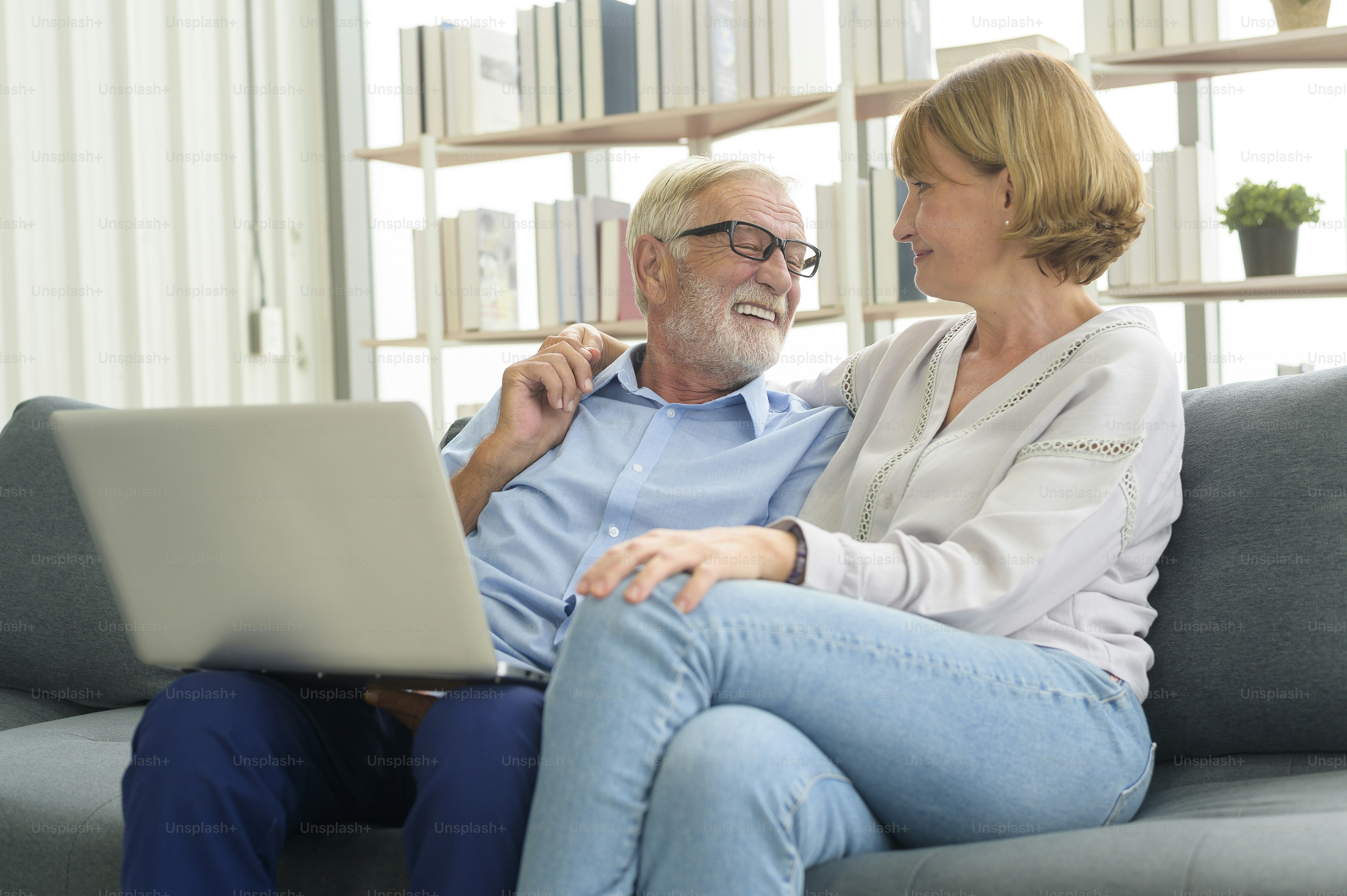 Happy Caucasian senior couple using laptop at home photo – Man and ...