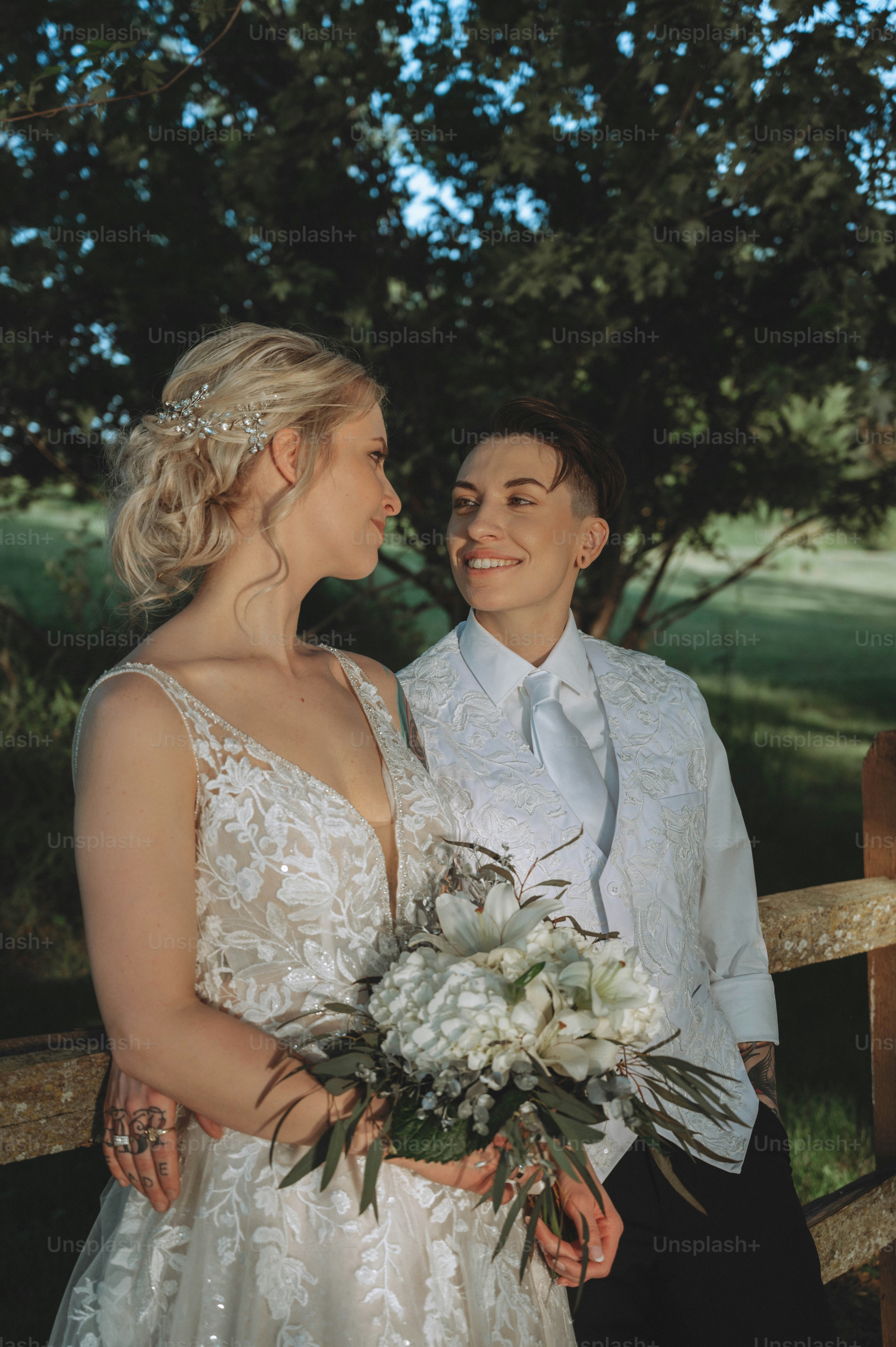 A man and a woman standing next to each other photo – Lgbt Image on ...