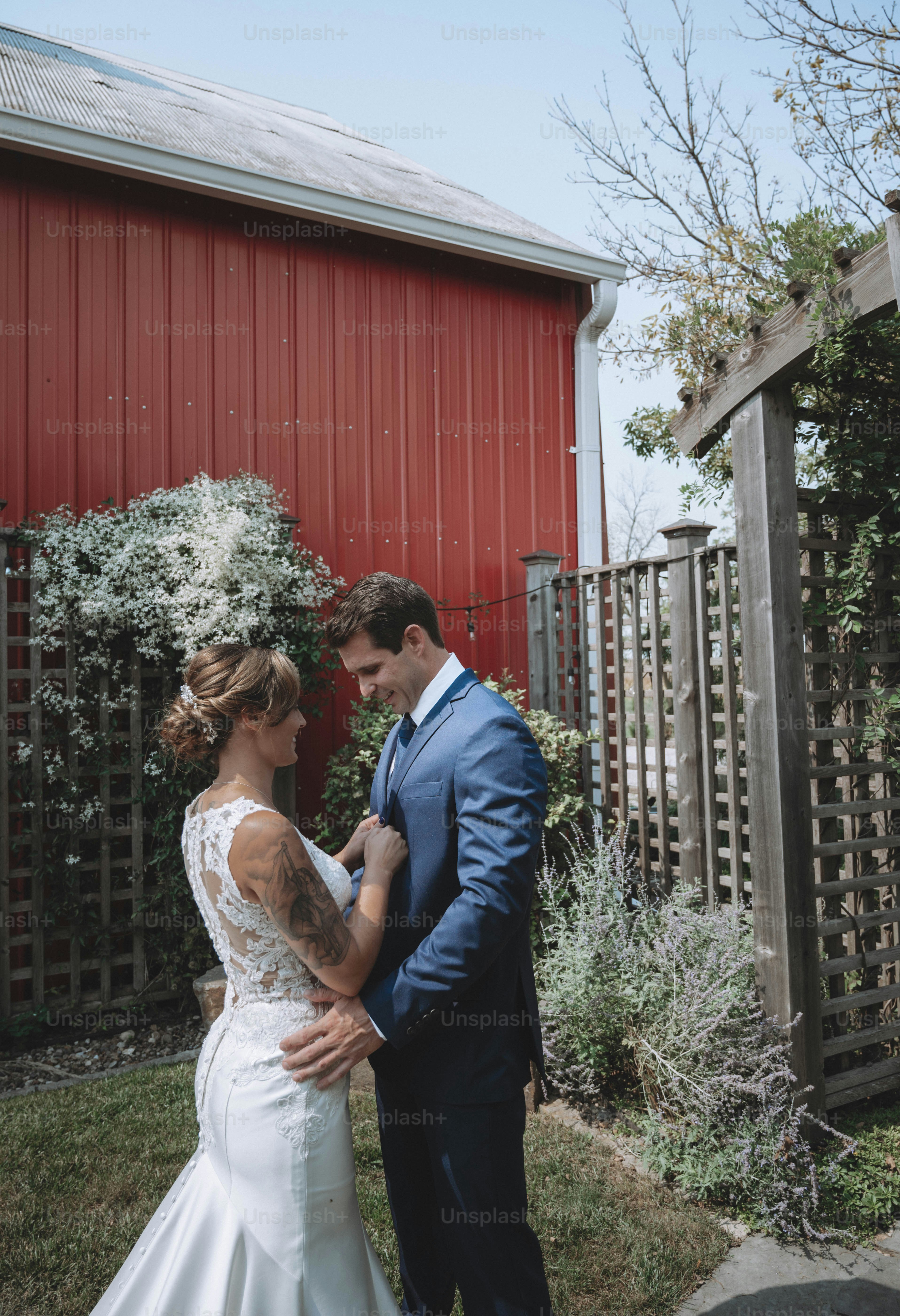 A bride and groom holding hands in a field photo – Wedding Image on ...