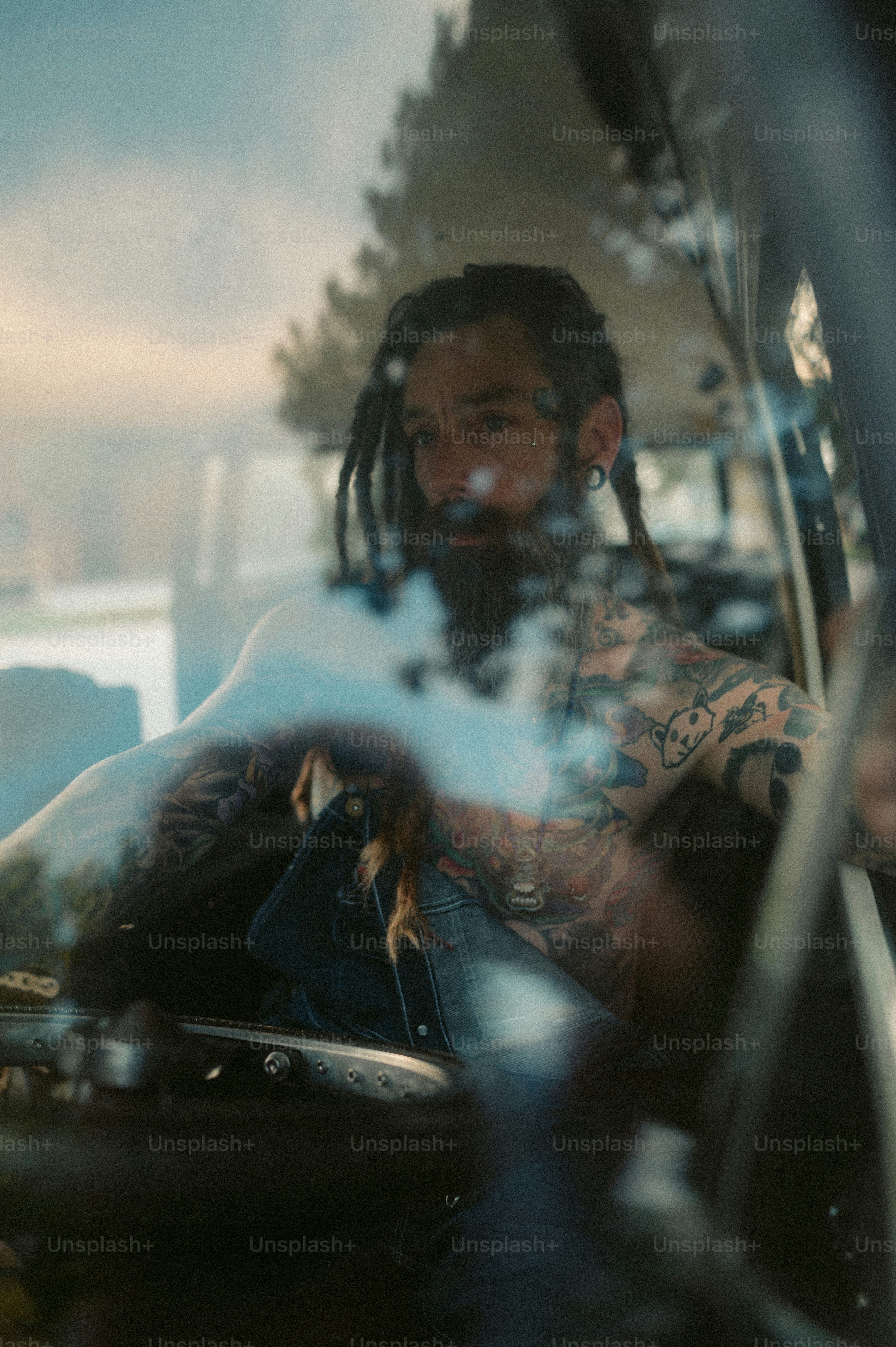 A man with dreadlocks sitting in a car photo – Portrait Image on Unsplash