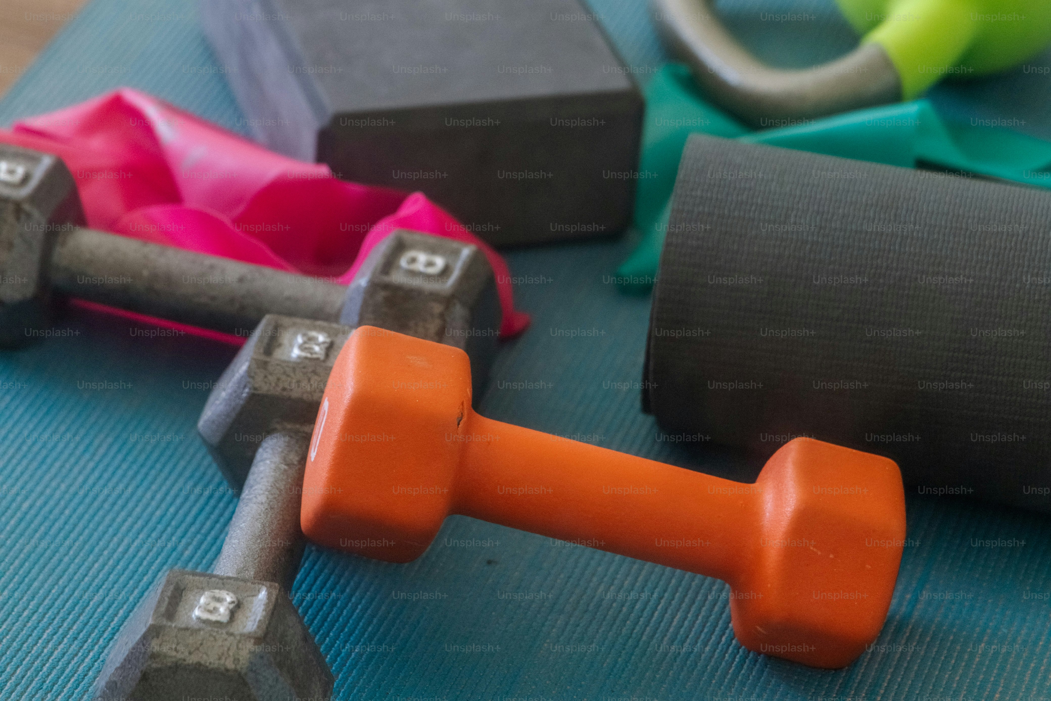 A variety of exercise equipment on a blue mat photo – Exercise ...