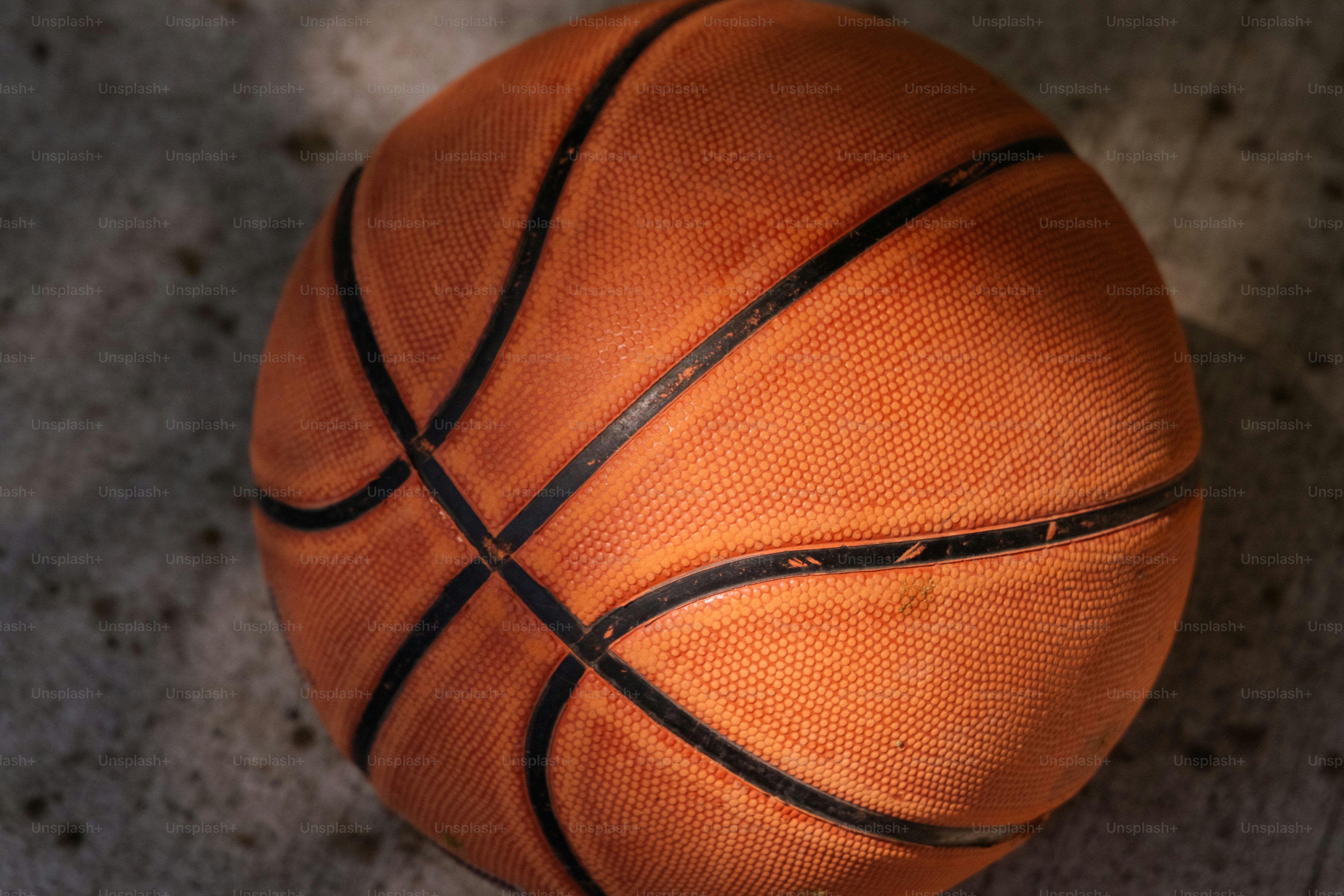 A close up of a basketball on the ground photo – Basketball Image on ...