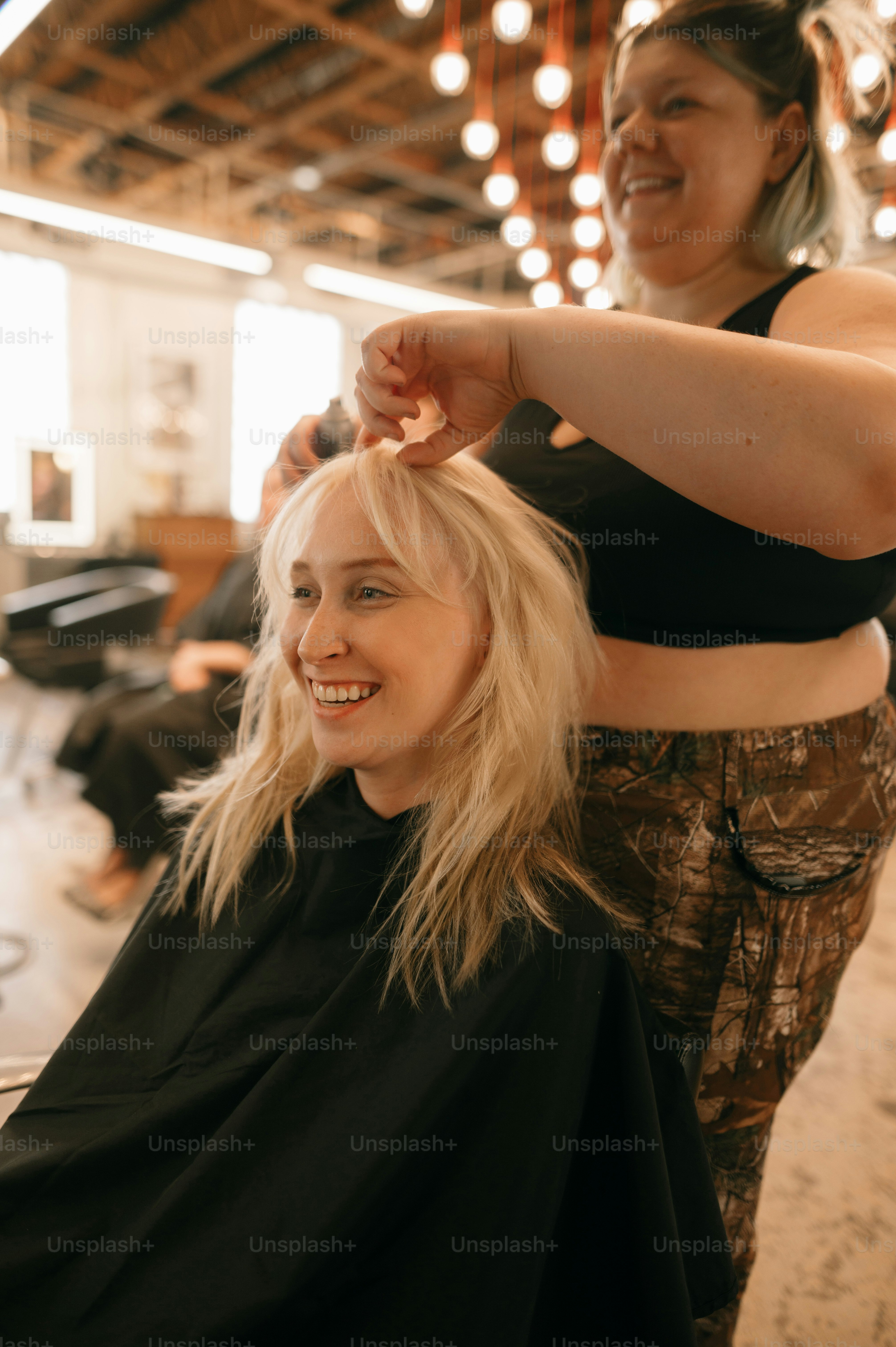 A woman cutting another woman's hair in a salon photo – Woman hair ...