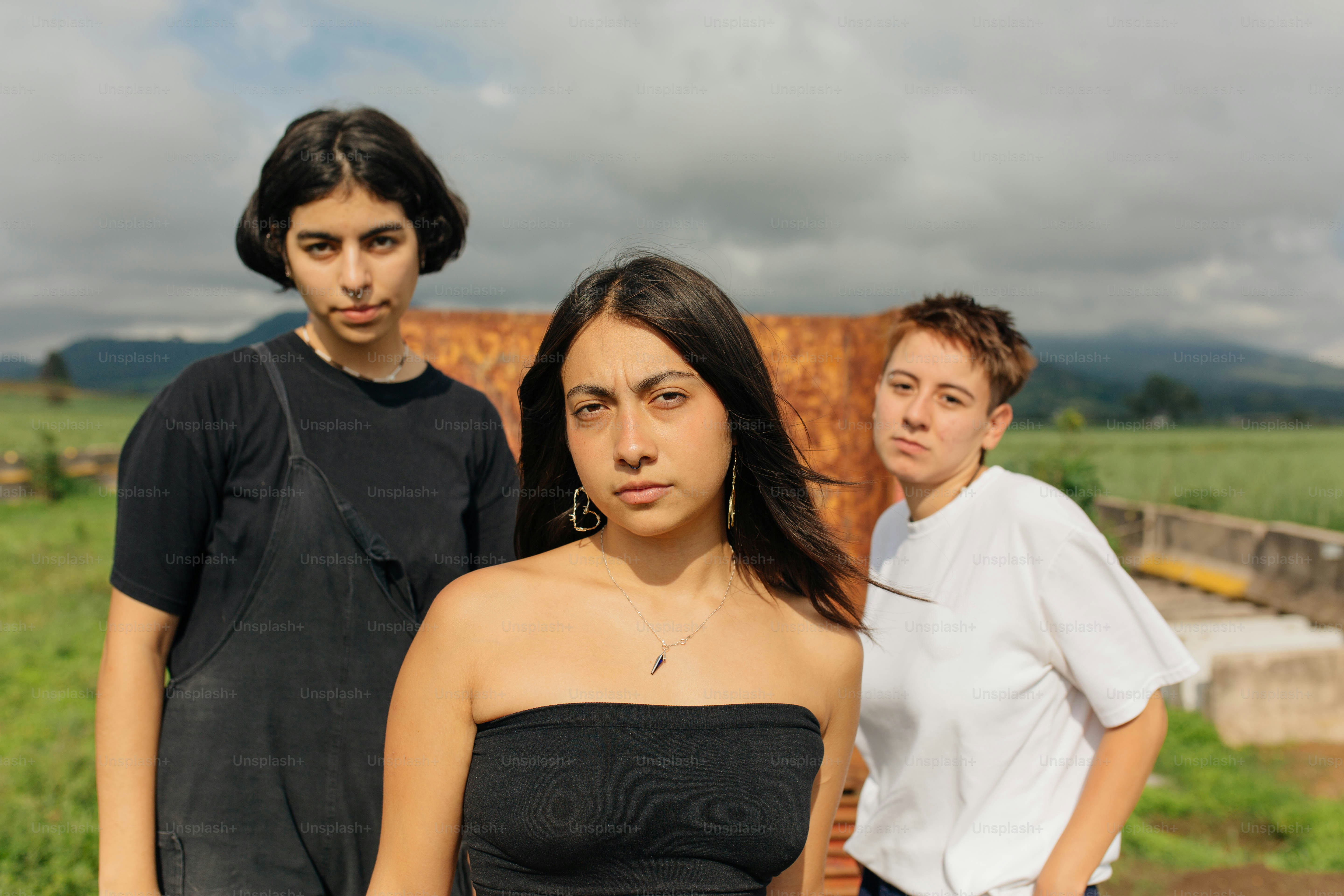 A group of three people standing next to each other photo – Portrait ...