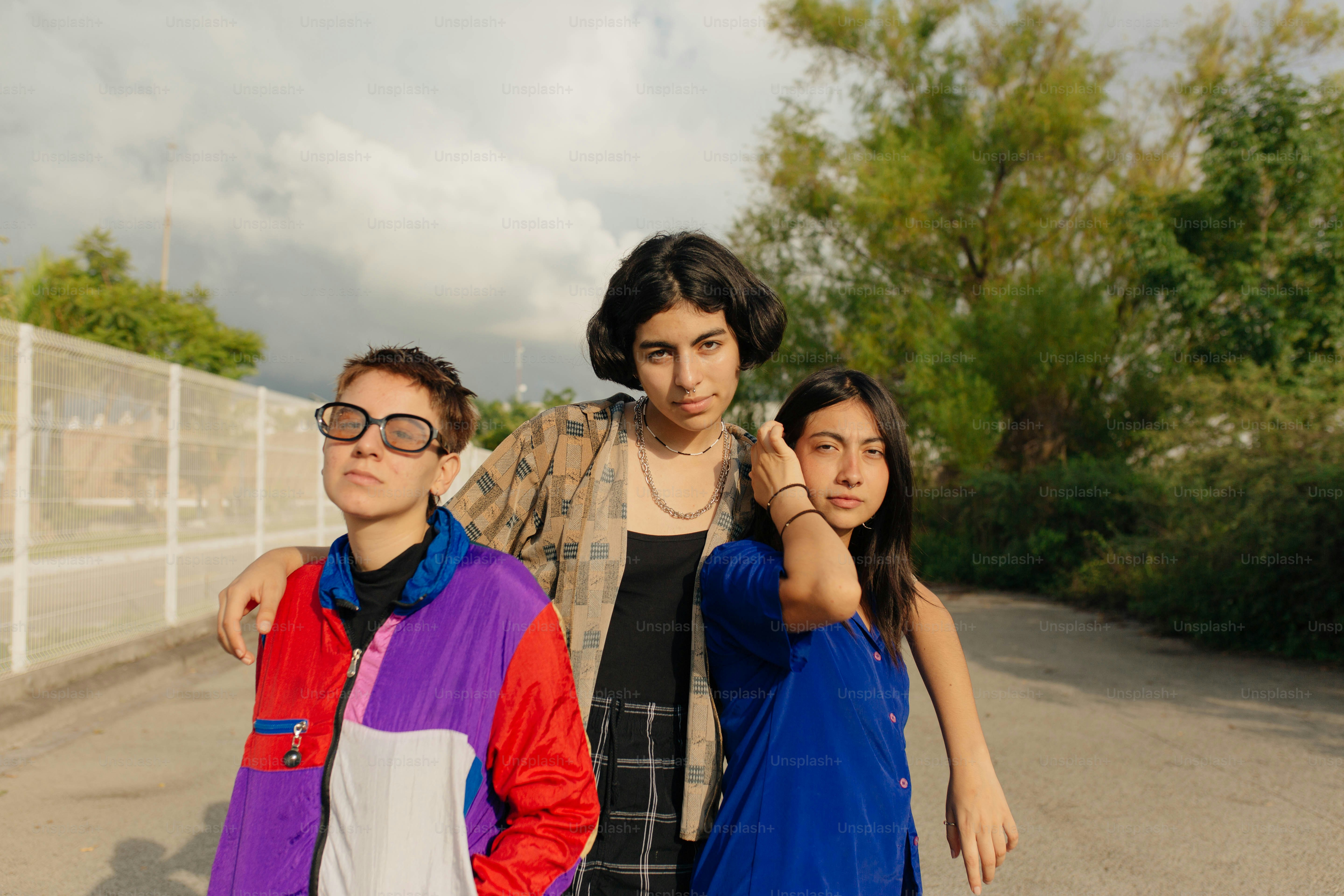 A group of three people standing next to each other photo – Portrait ...