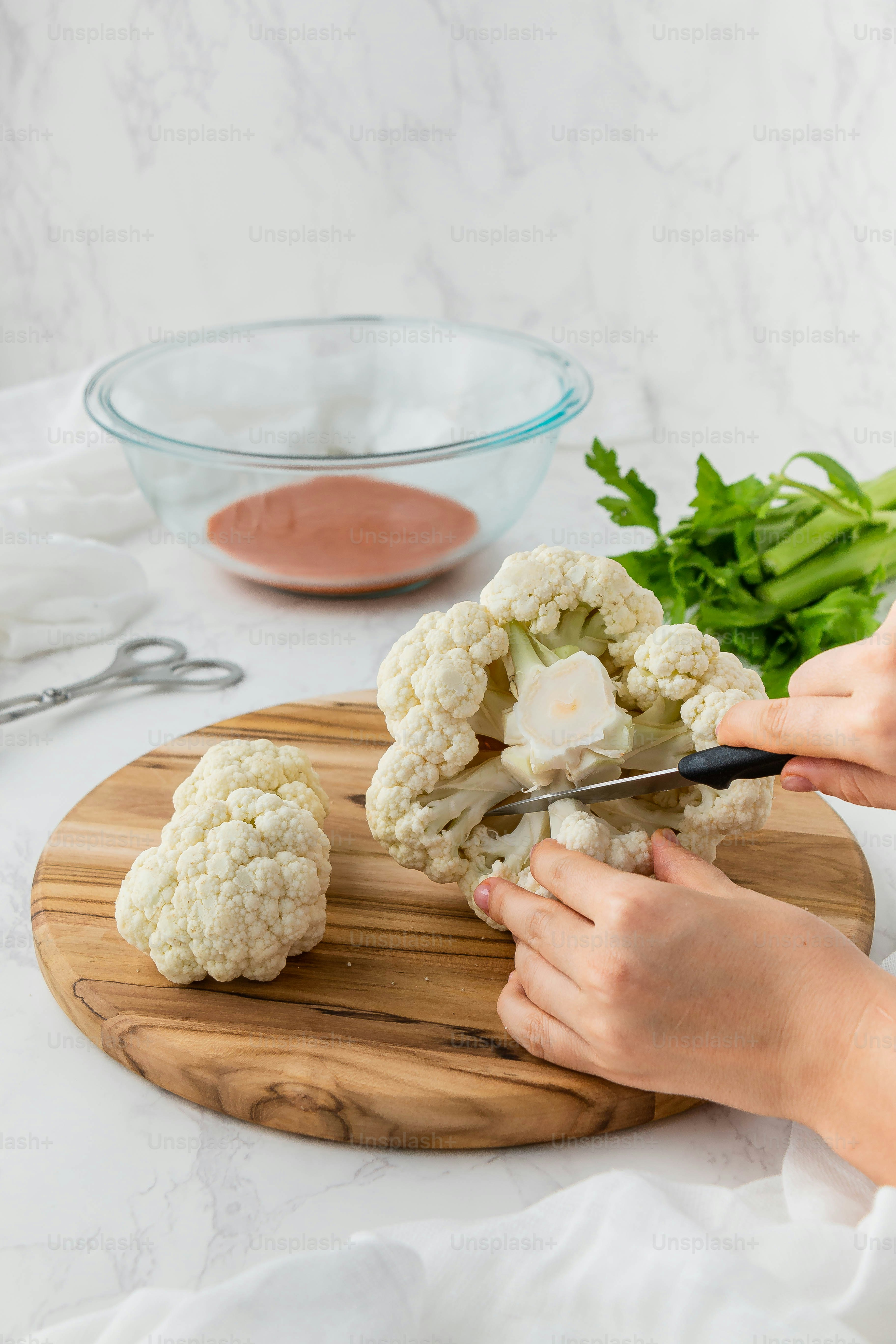 A person scooping cauliflower into a bowl photo – Vegetarian Image on ...