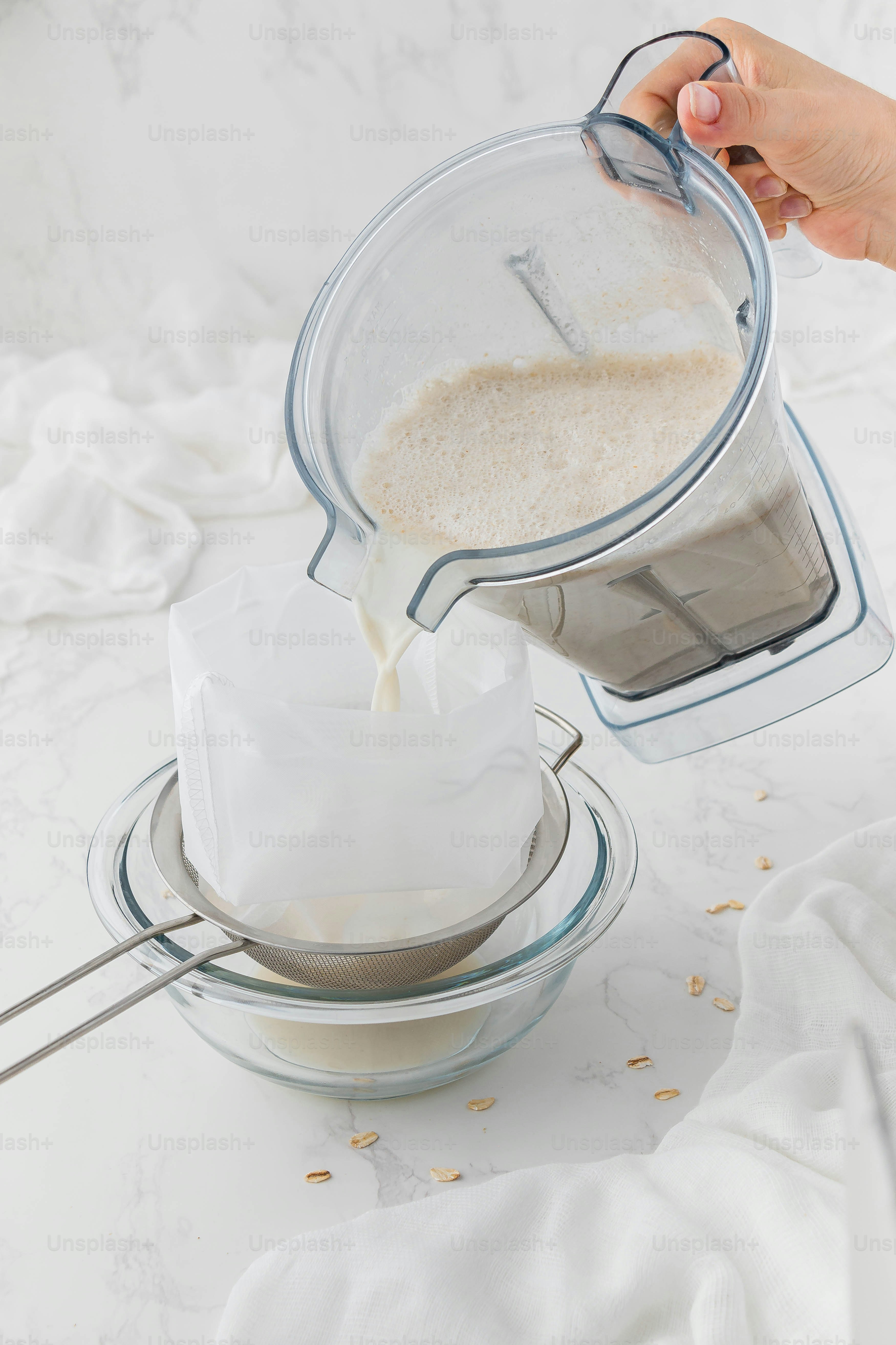 A person pouring a mixture into a blender photo – Straining Image on ...