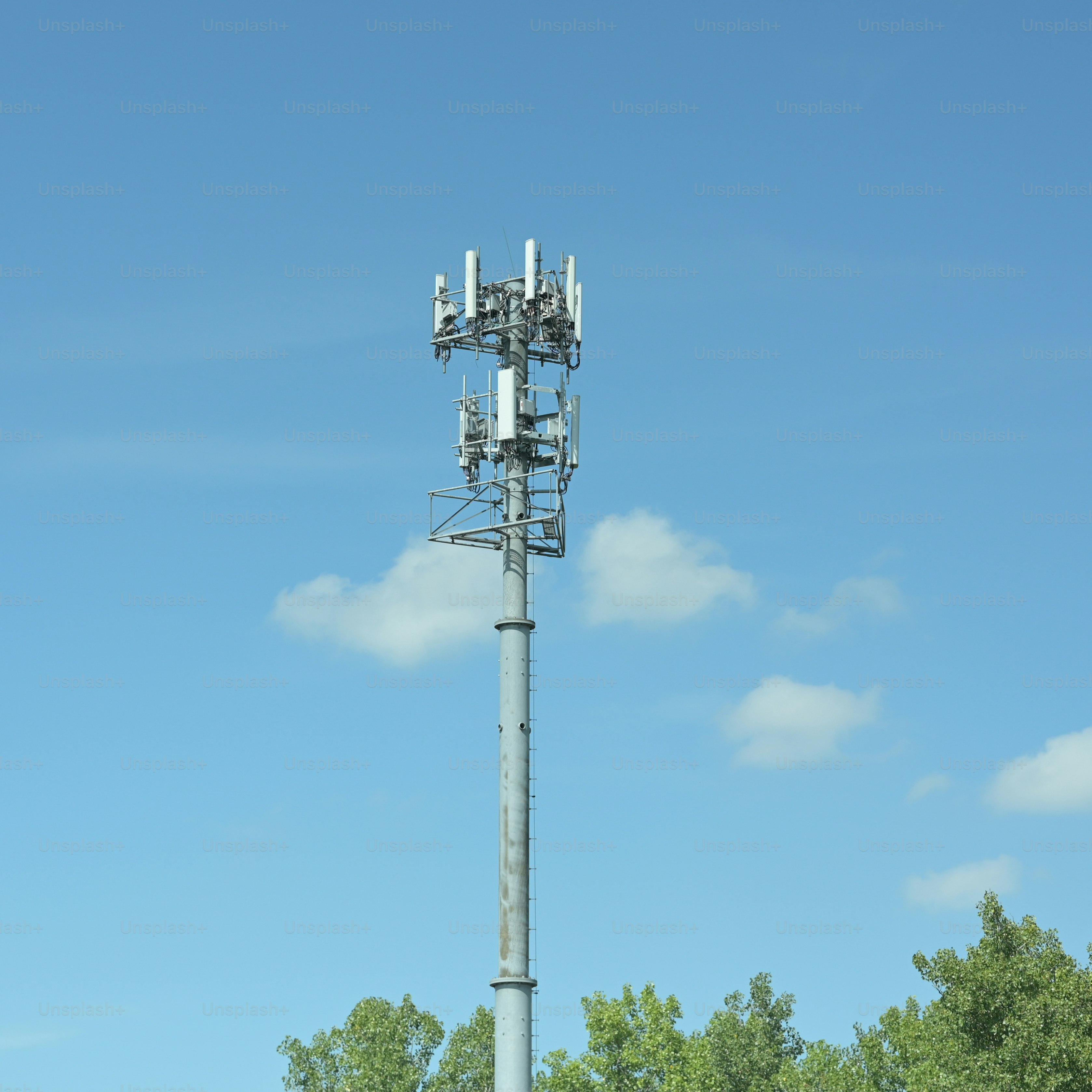 A tall metal pole with a bunch of cell phones on top of it photo ...