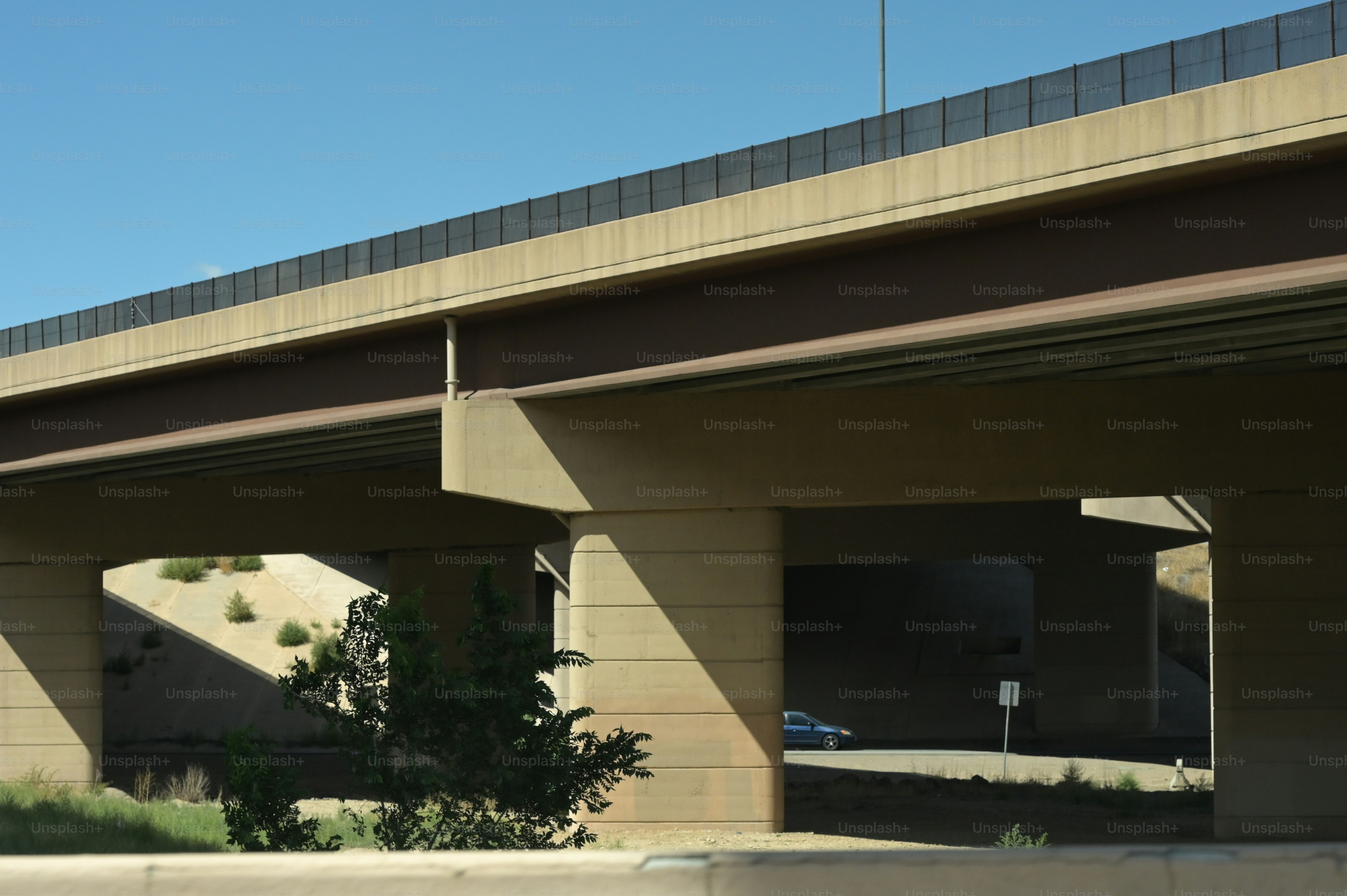 A view of a freeway overpass with a car going under it photo ...