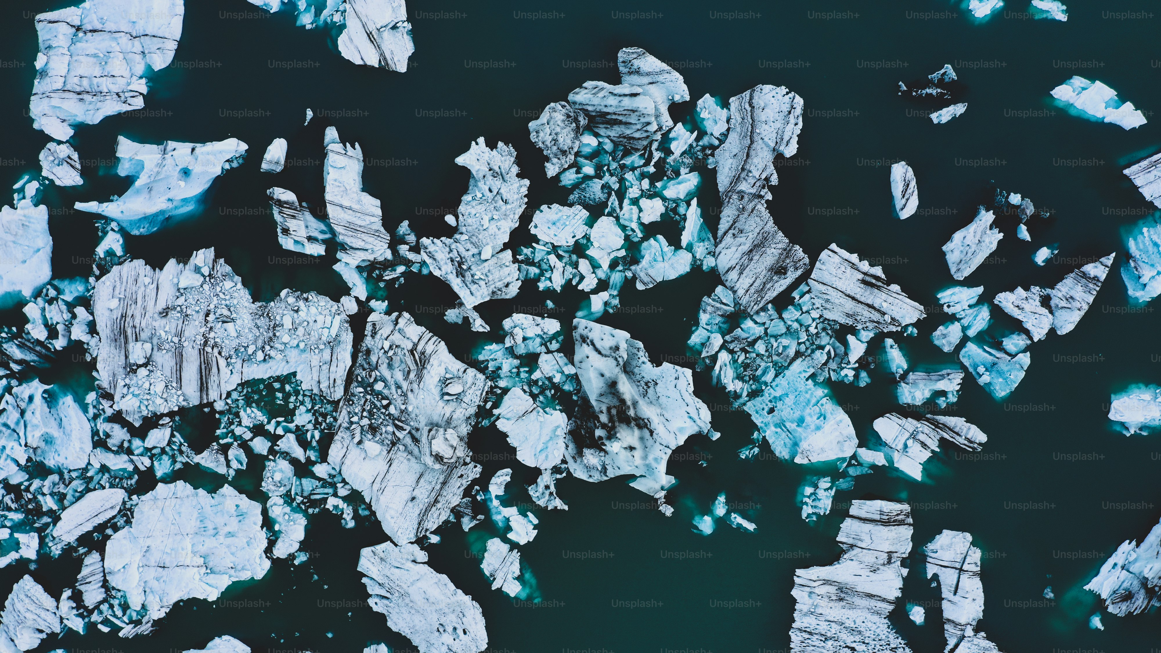 An aerial view of ice chunks in the water photo – Iceberg Image on Unsplash
