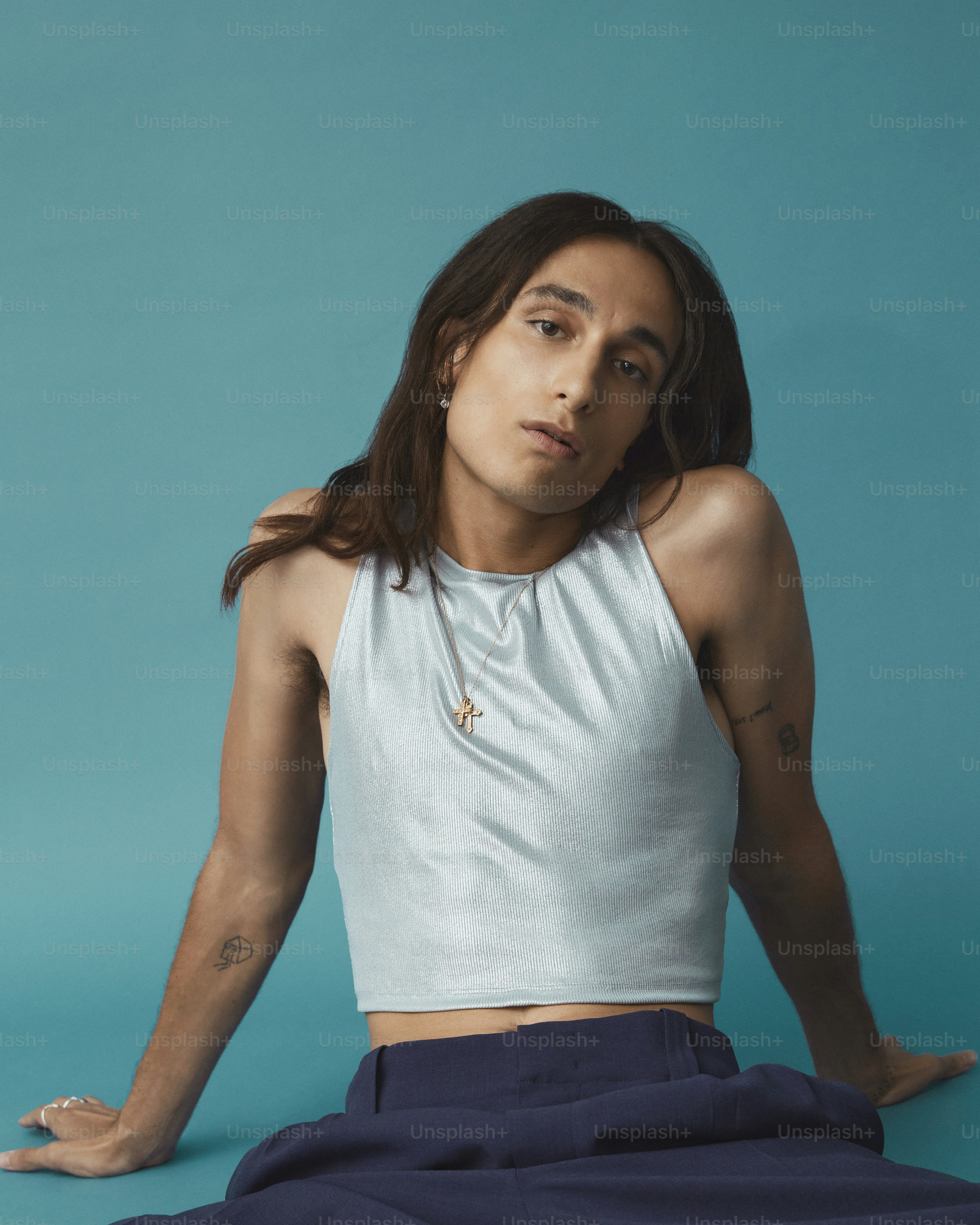 A woman sitting on the ground wearing a white top photo – Studio shoot ...