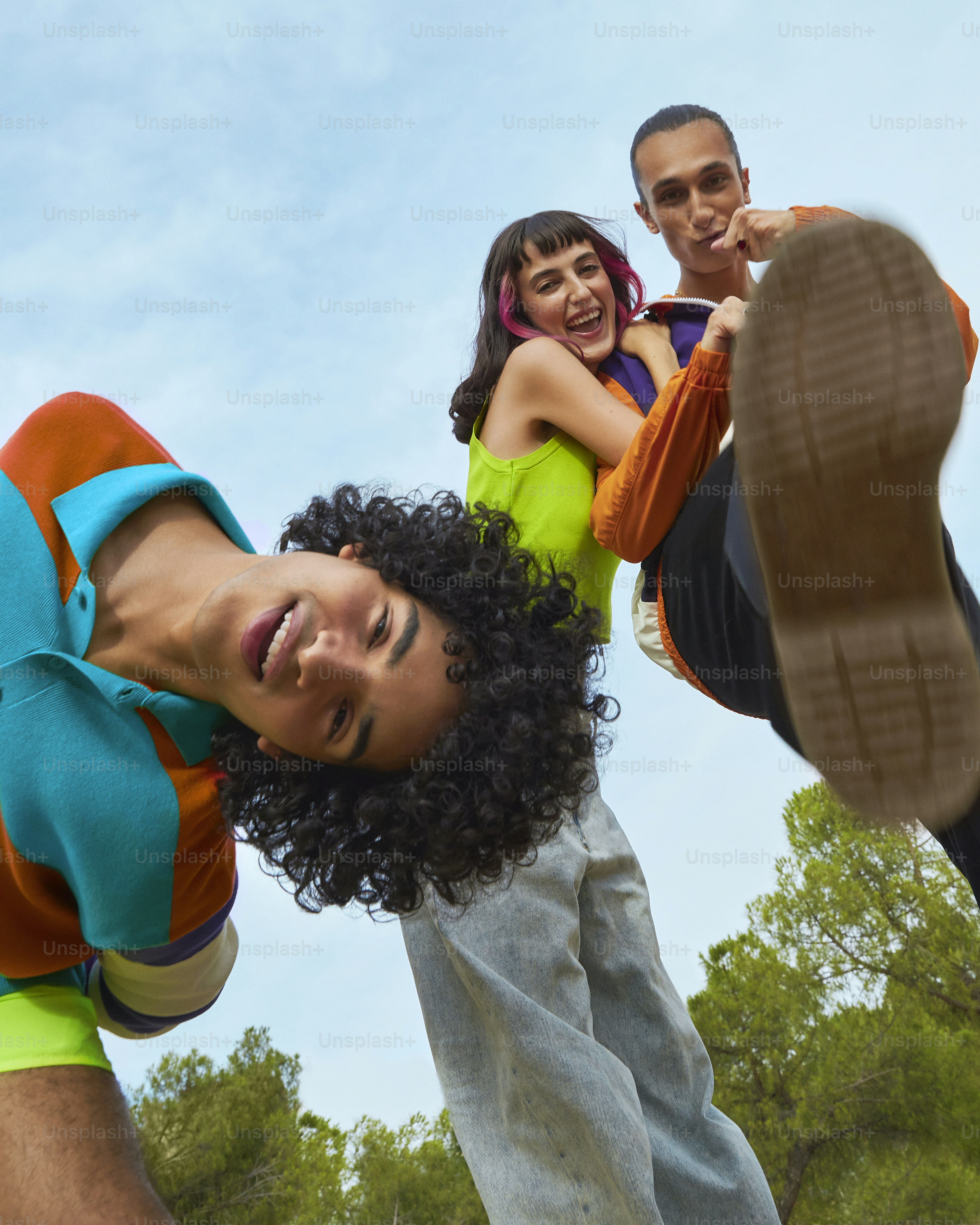 A group of people hanging upside down in the air photo – People outside ...