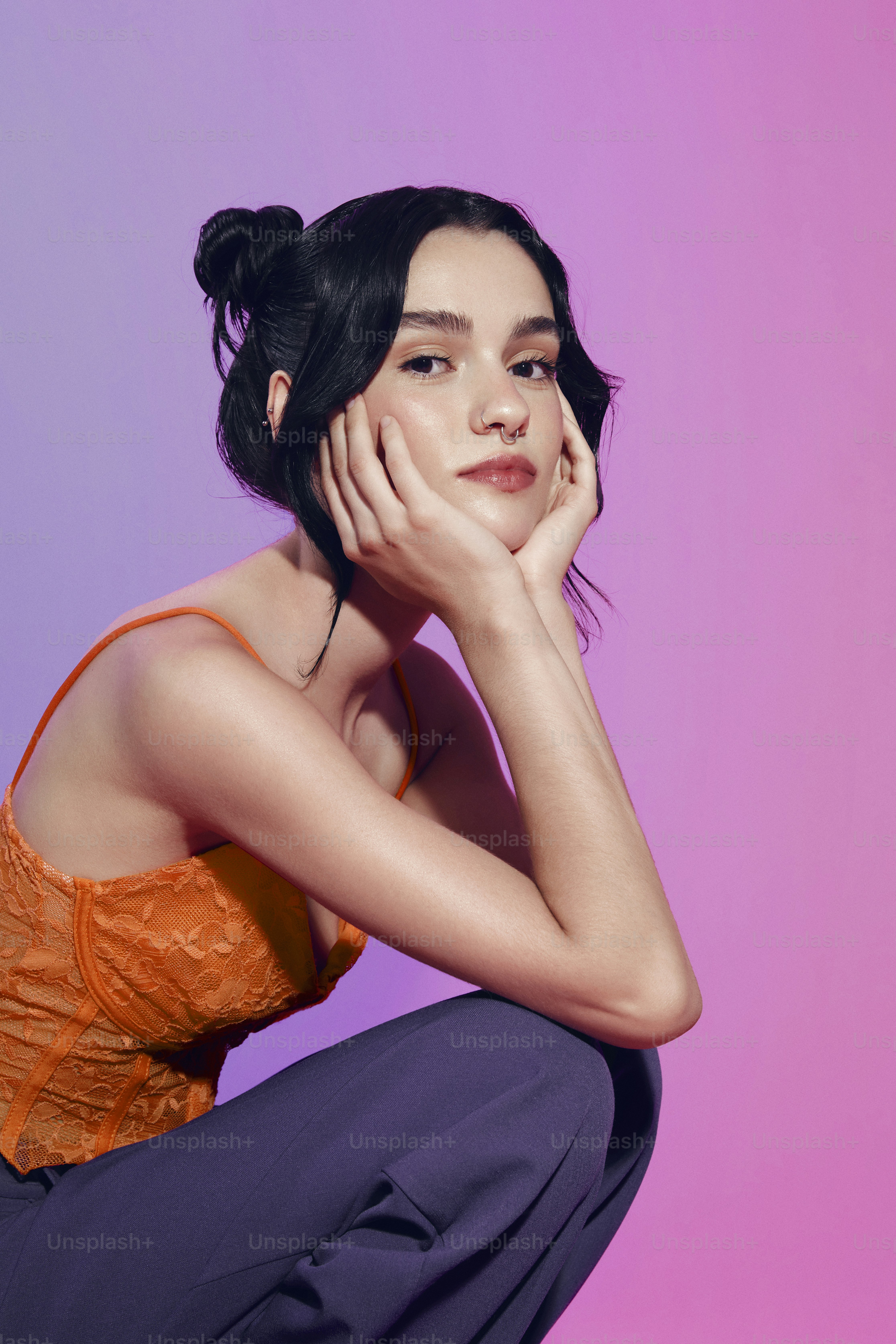 Une femme assise par terre avec sa main sur son visage photo – Femme ...