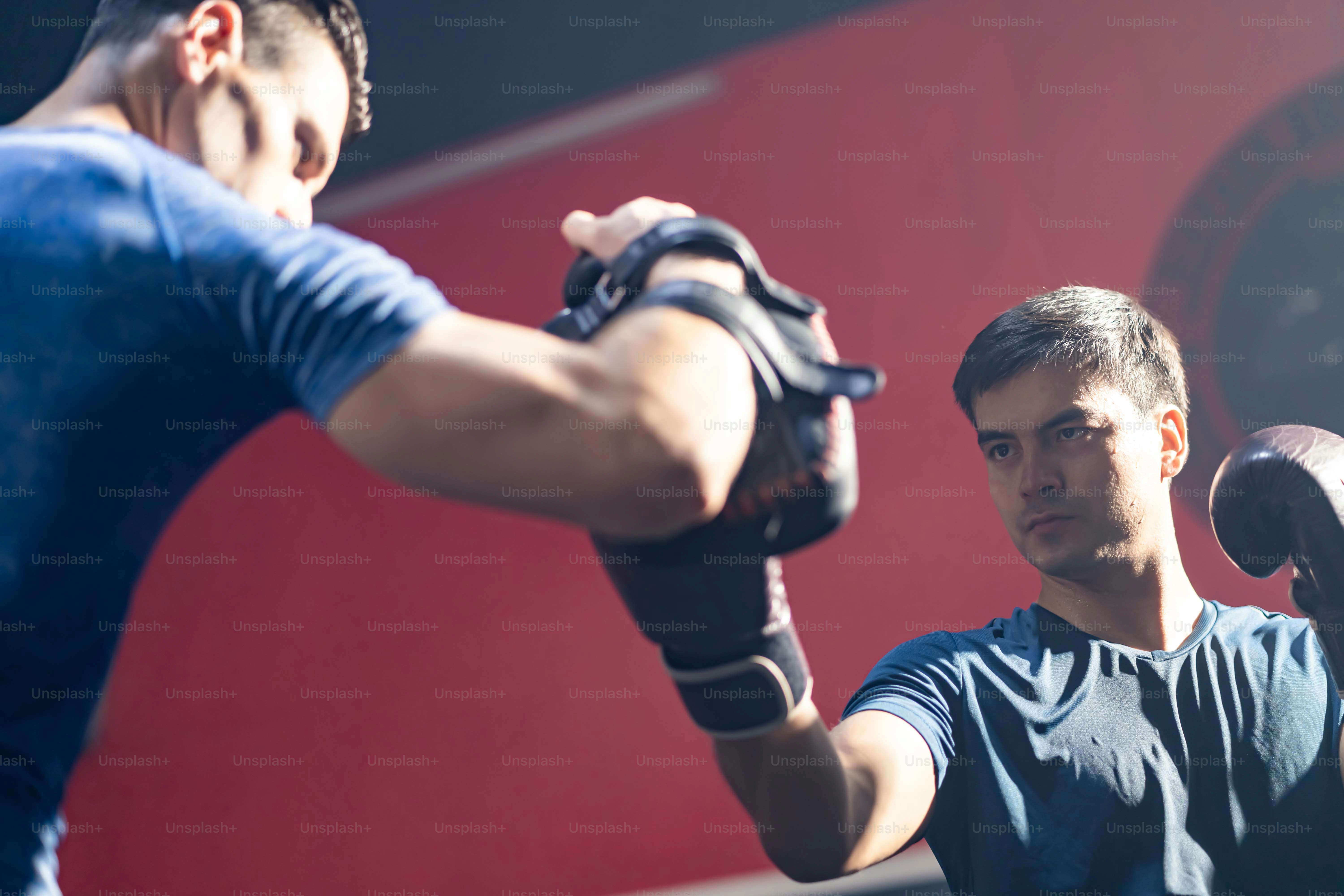 Caucasian Fitness instructor teach and motivate young sportsman boxer ...