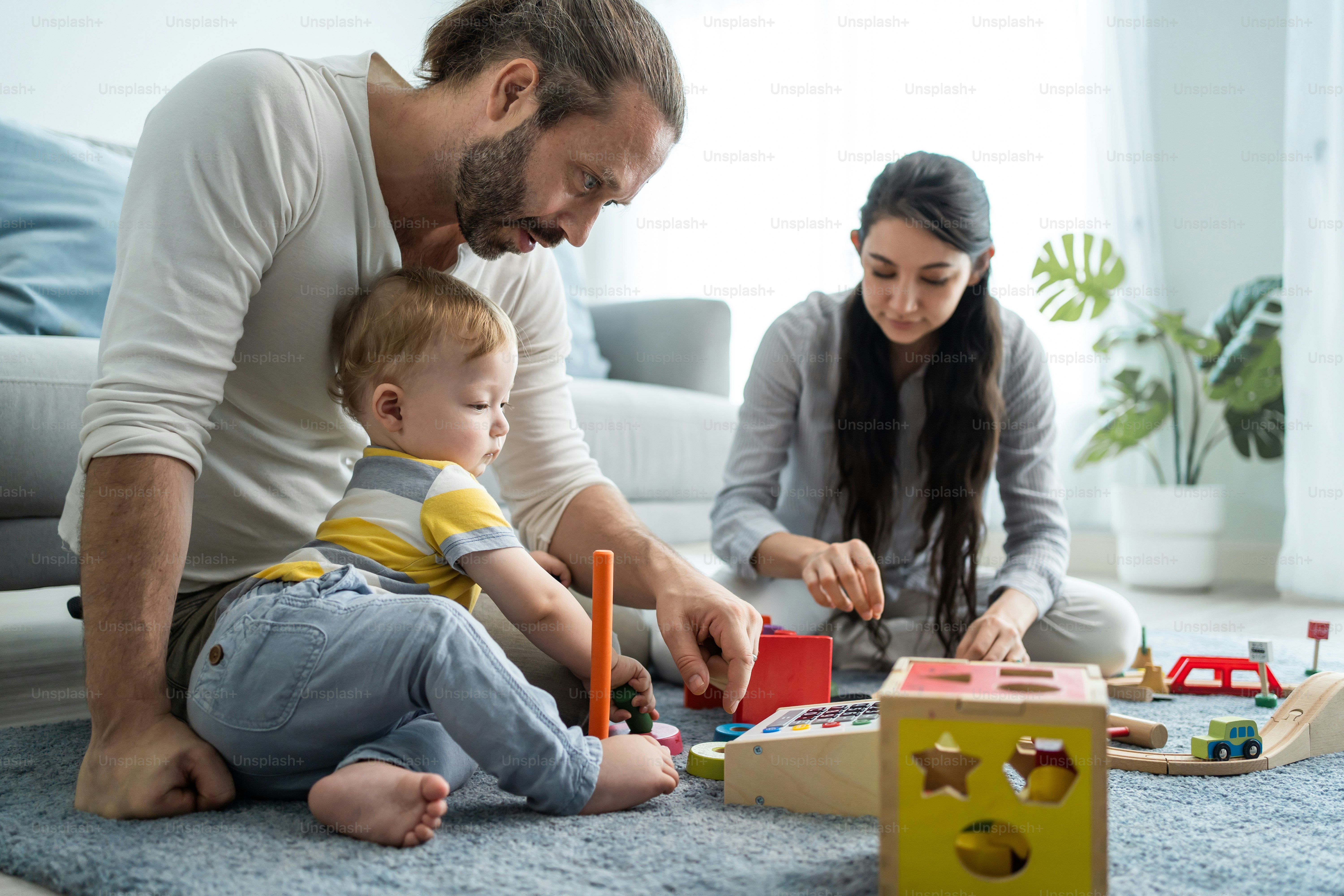 Caucasian happy loving parent play with baby toddler in living room ...