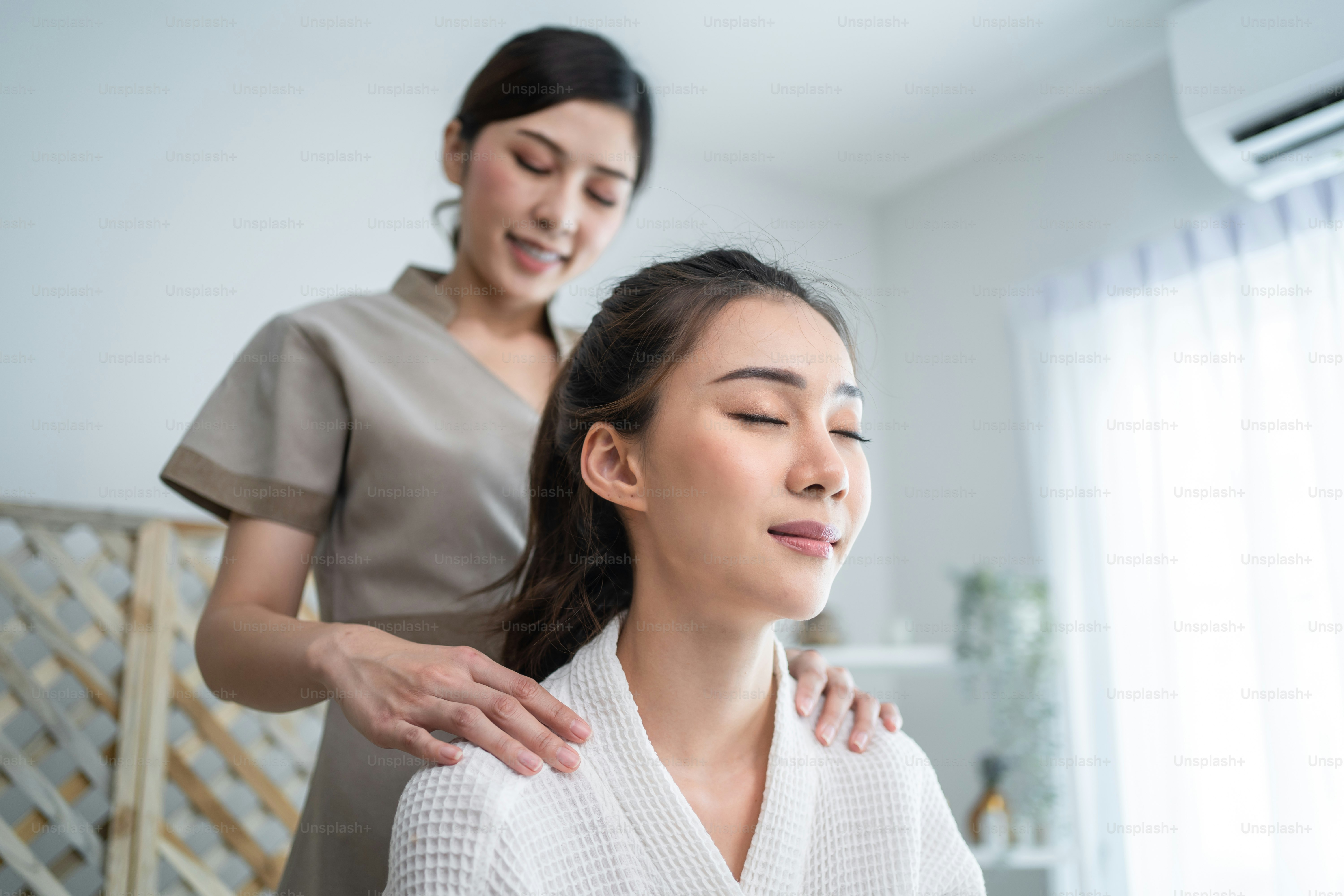 Close up of young client girl feel relaxed during leg massage with oil. Attractive beautiful ...