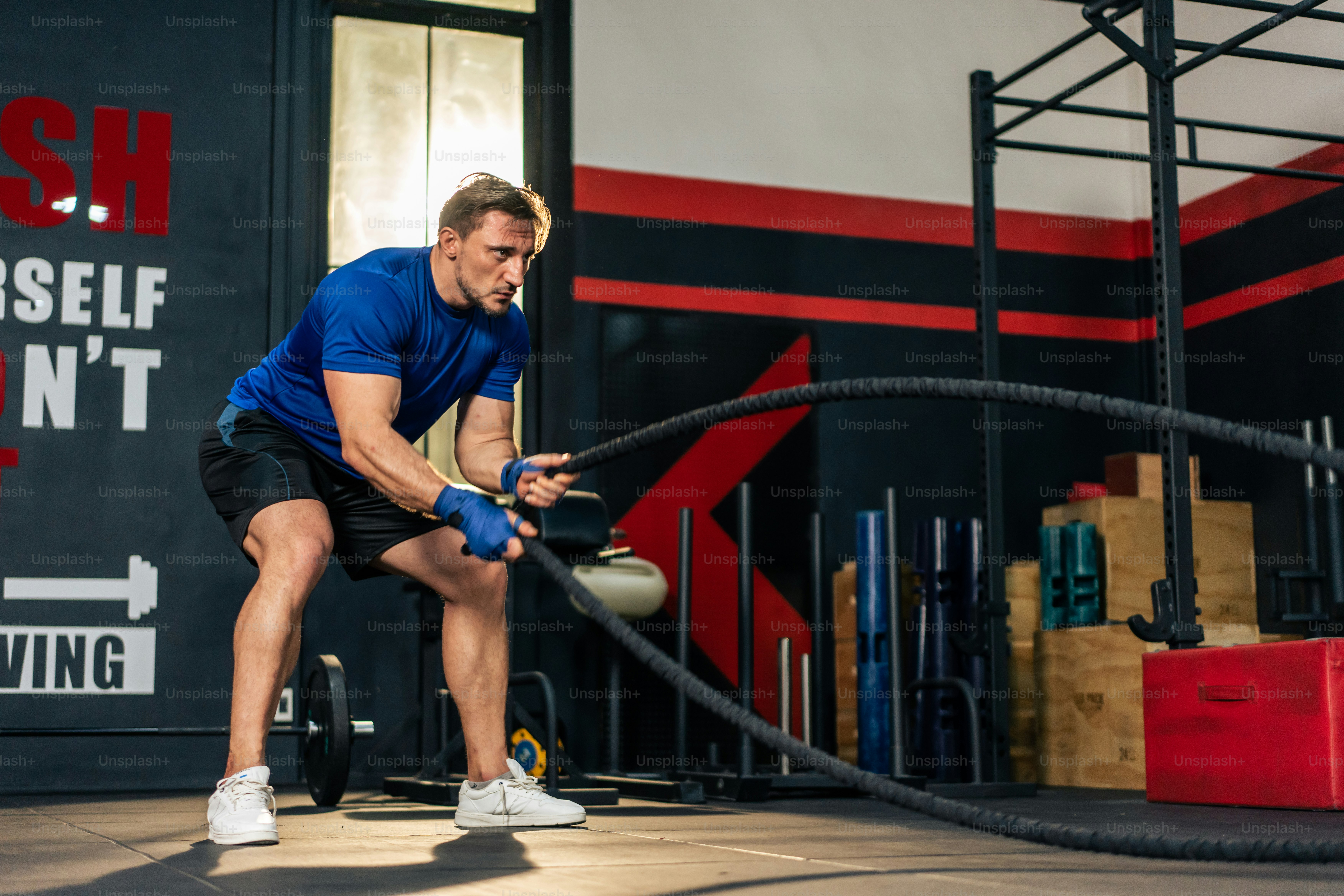 Caucasian active handsome sportsman working out in fitness gym club ...
