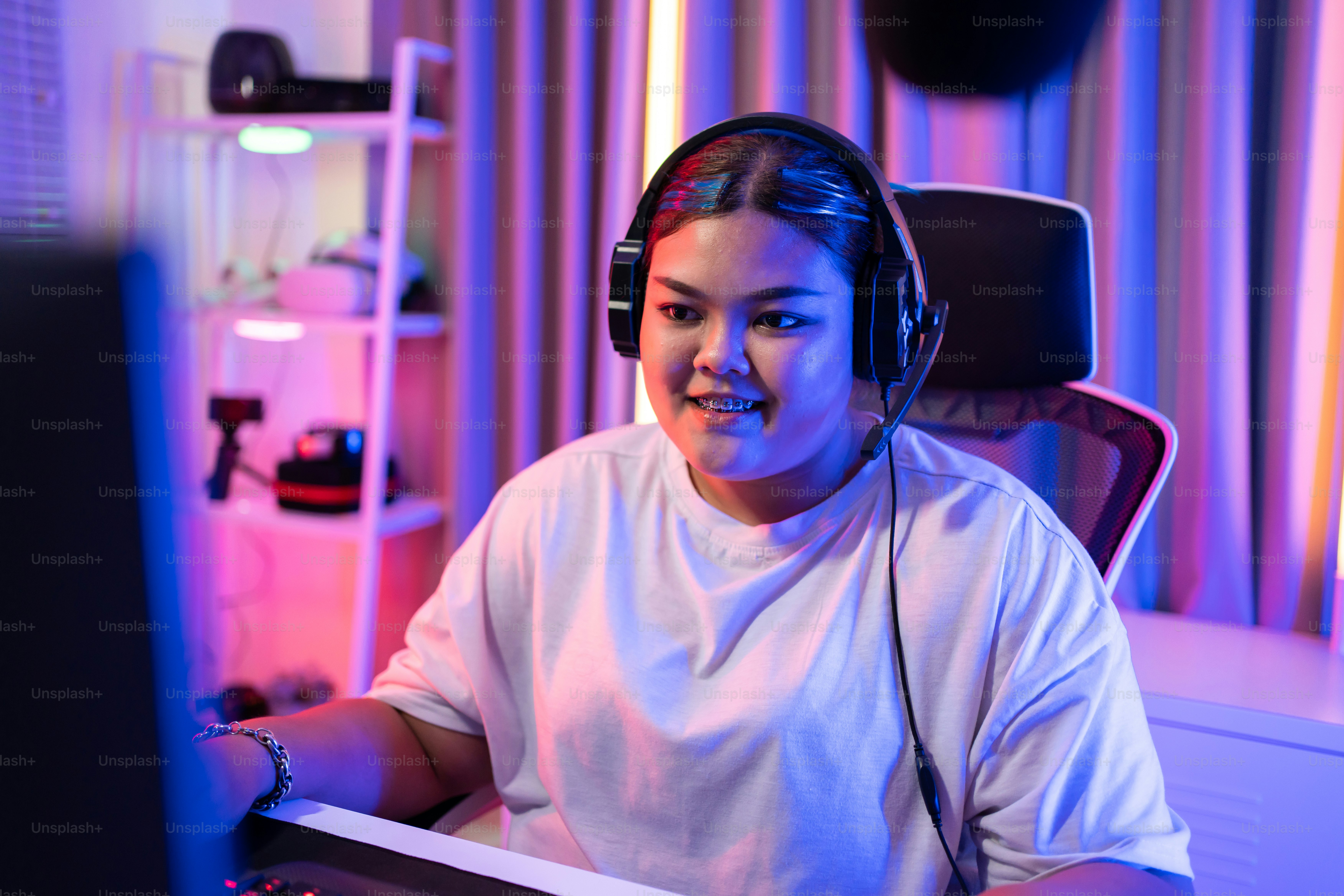 Asian beautiful Esport woman gamer play online video game on computer. Attractive young girl ...