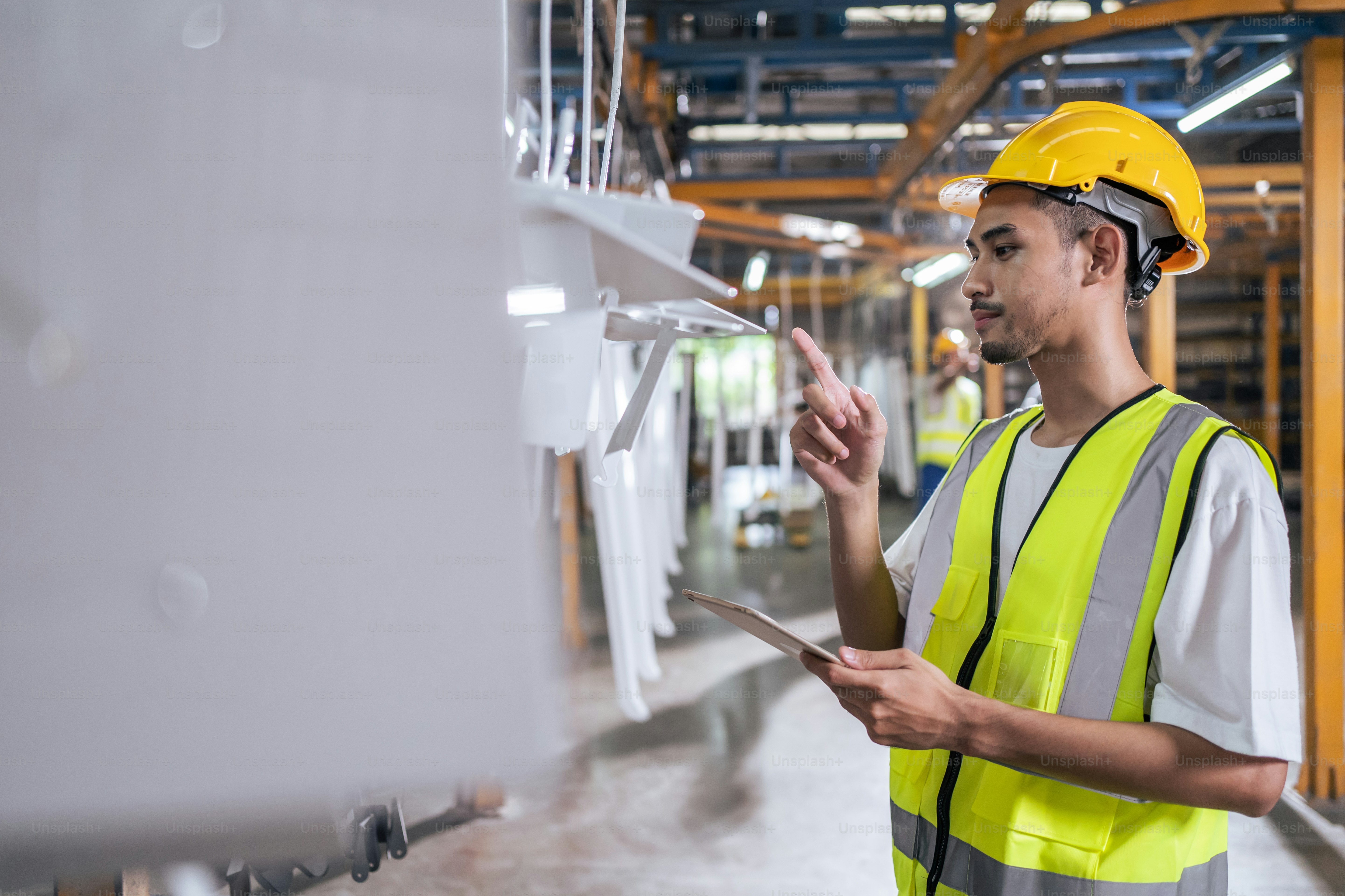 Asian attractive man industrial worker working in manufacturing plant ...