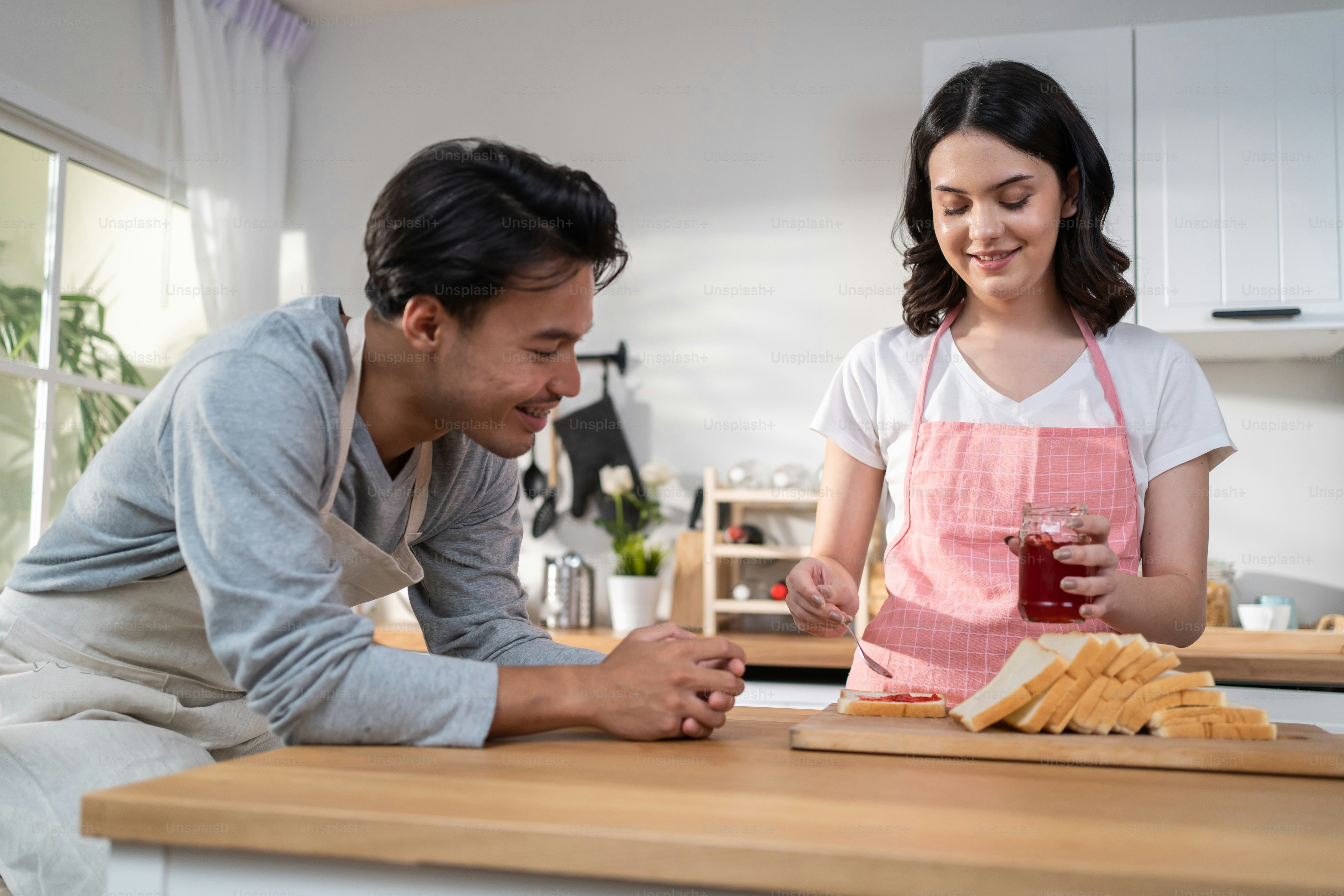 Asian young new marriage couple spend time together in kitchen at home ...