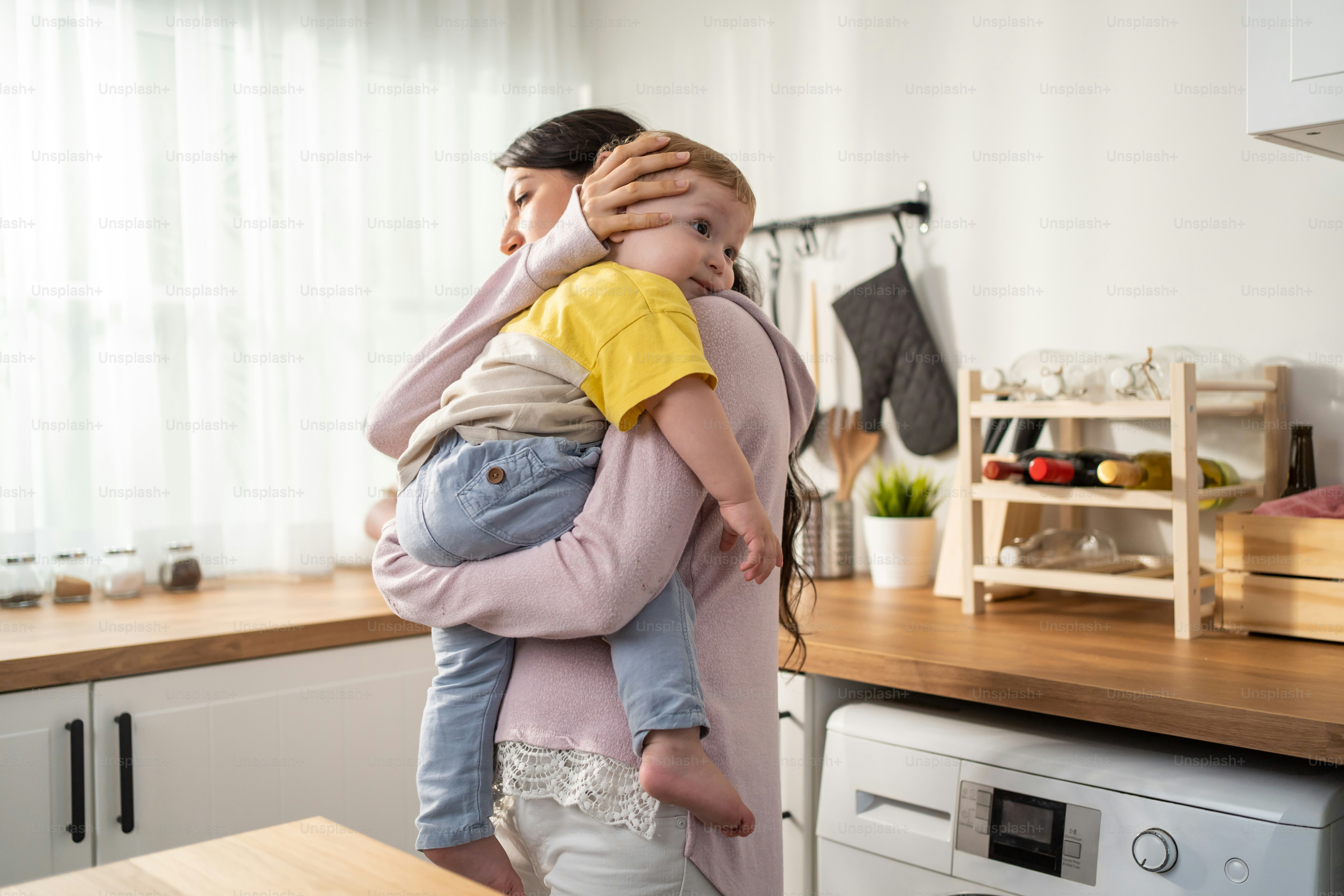 Caucasian loving mother hold baby boy toddler to lull him to sleep ...