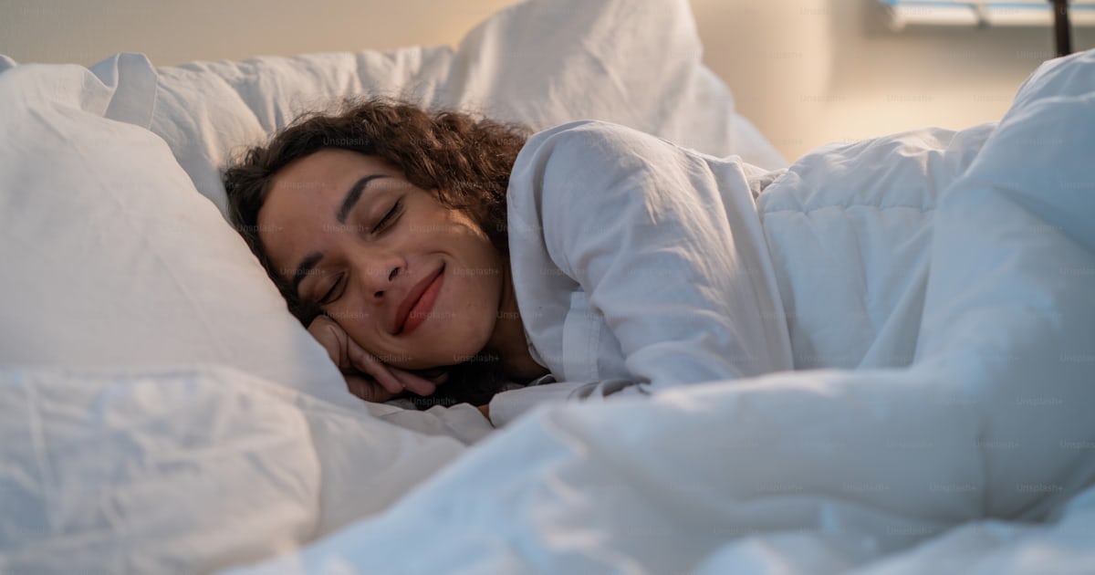 Latino Beautiful Woman Lying Down On Bed In Bedroom In Dark Night Room
