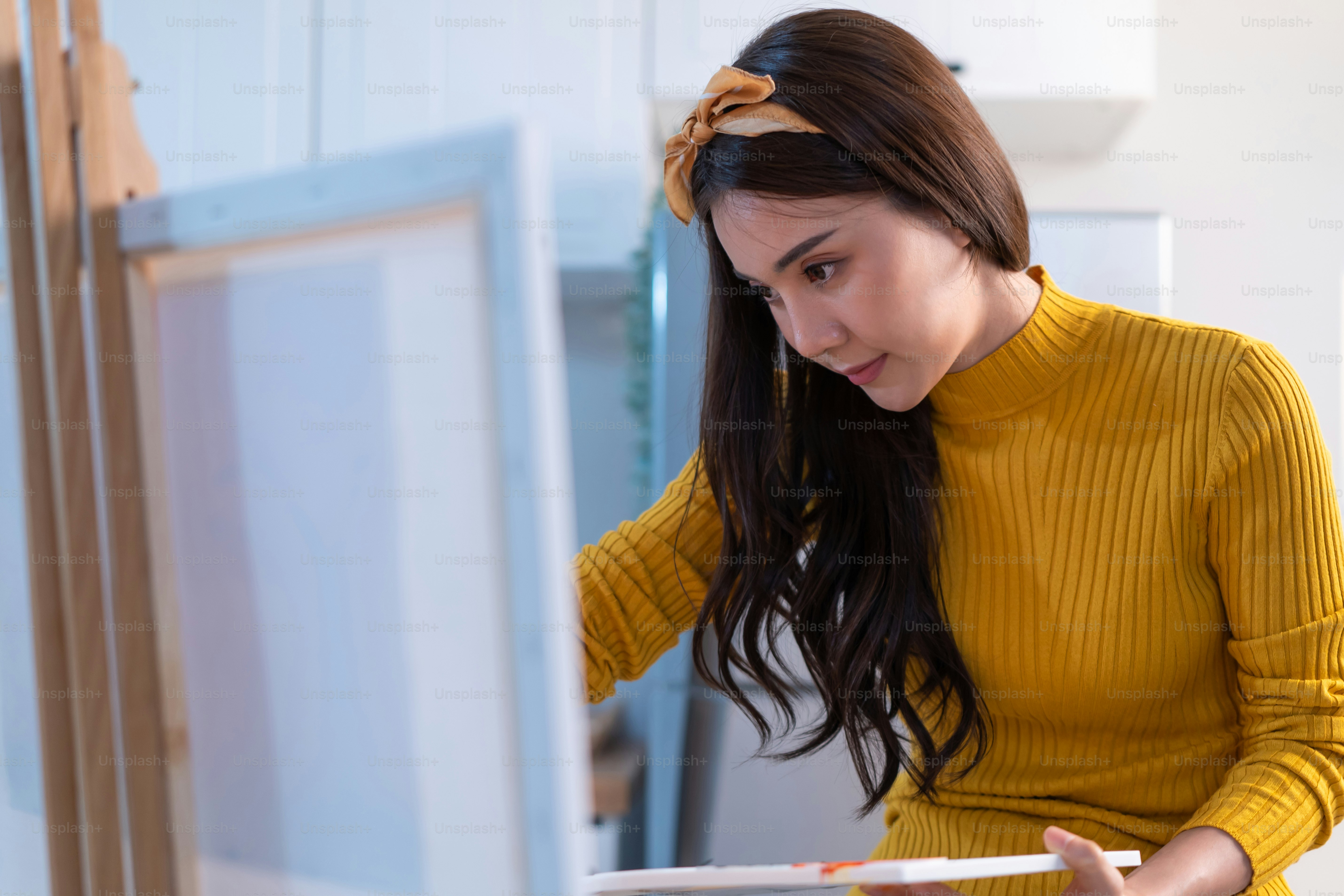 Close up of talented woman artist drawing picture on painting board ...